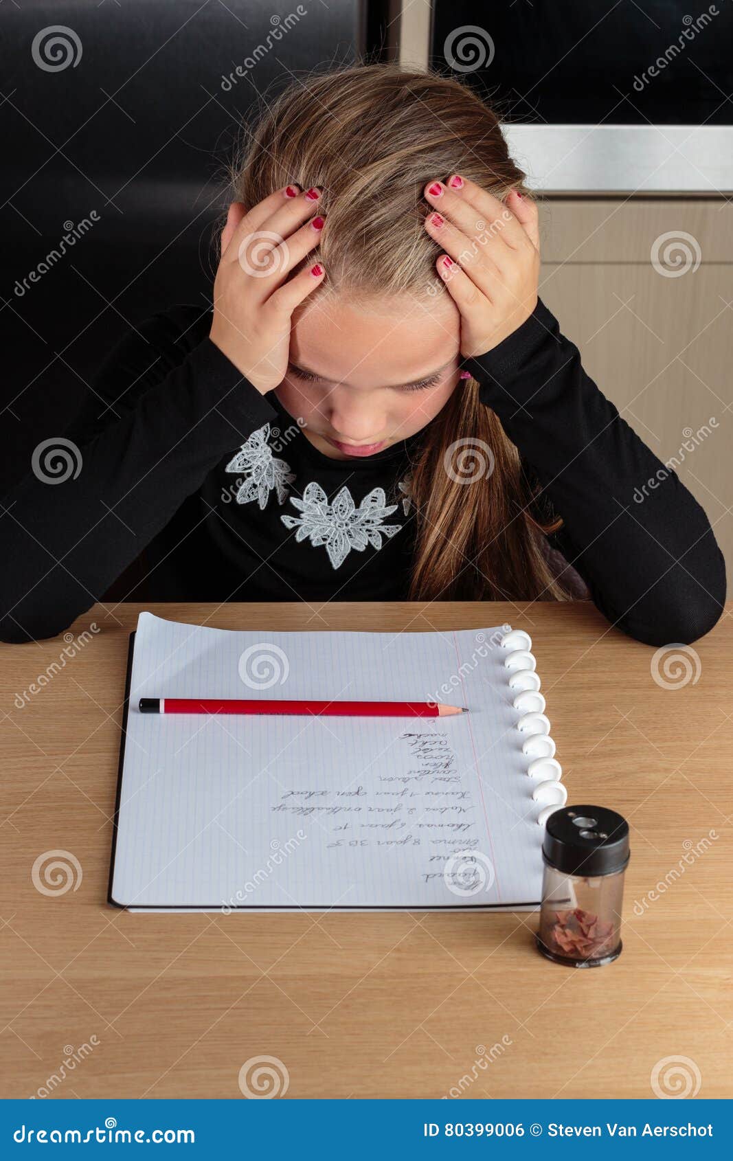 Worried Young Girl Doing Homework at the Kitchen Table Stock Photo ...