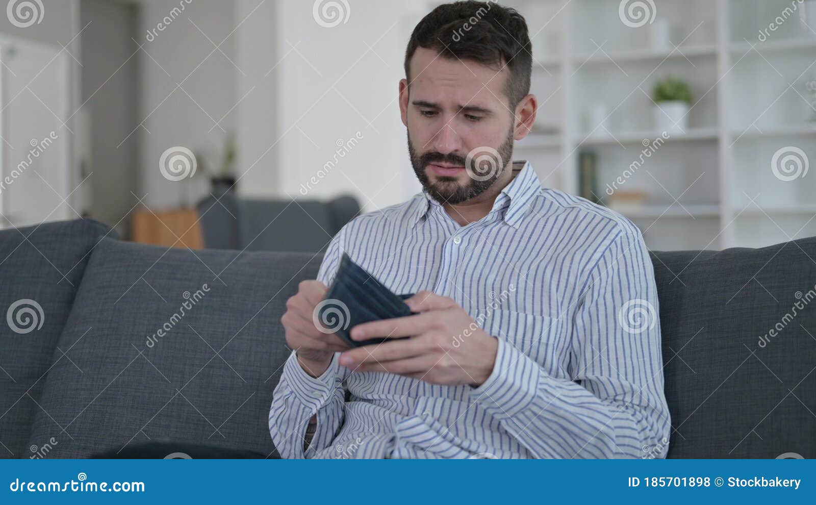 Worried Young Man Checking Empty Pocket for Money at Home Stock Photo ...
