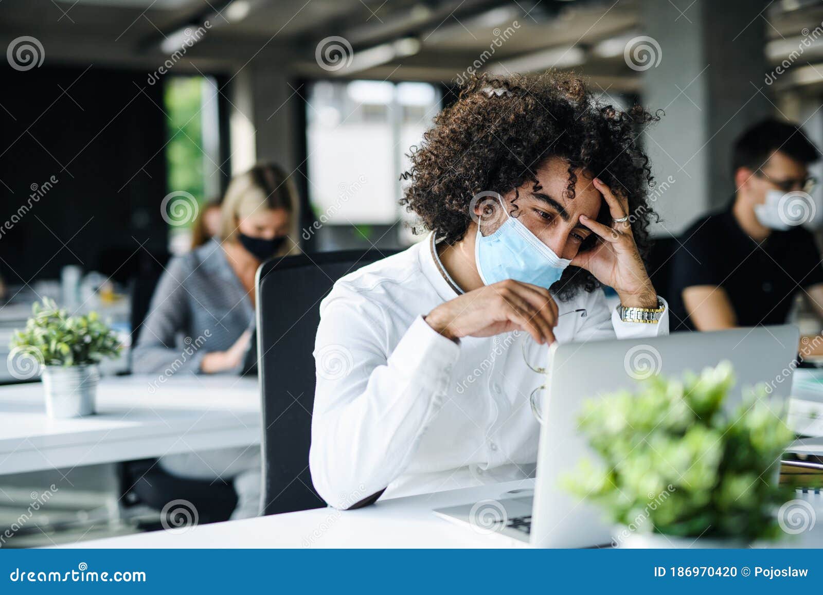 Worried Young Man with Face Mask Back at Work in Office after Lockdown ...