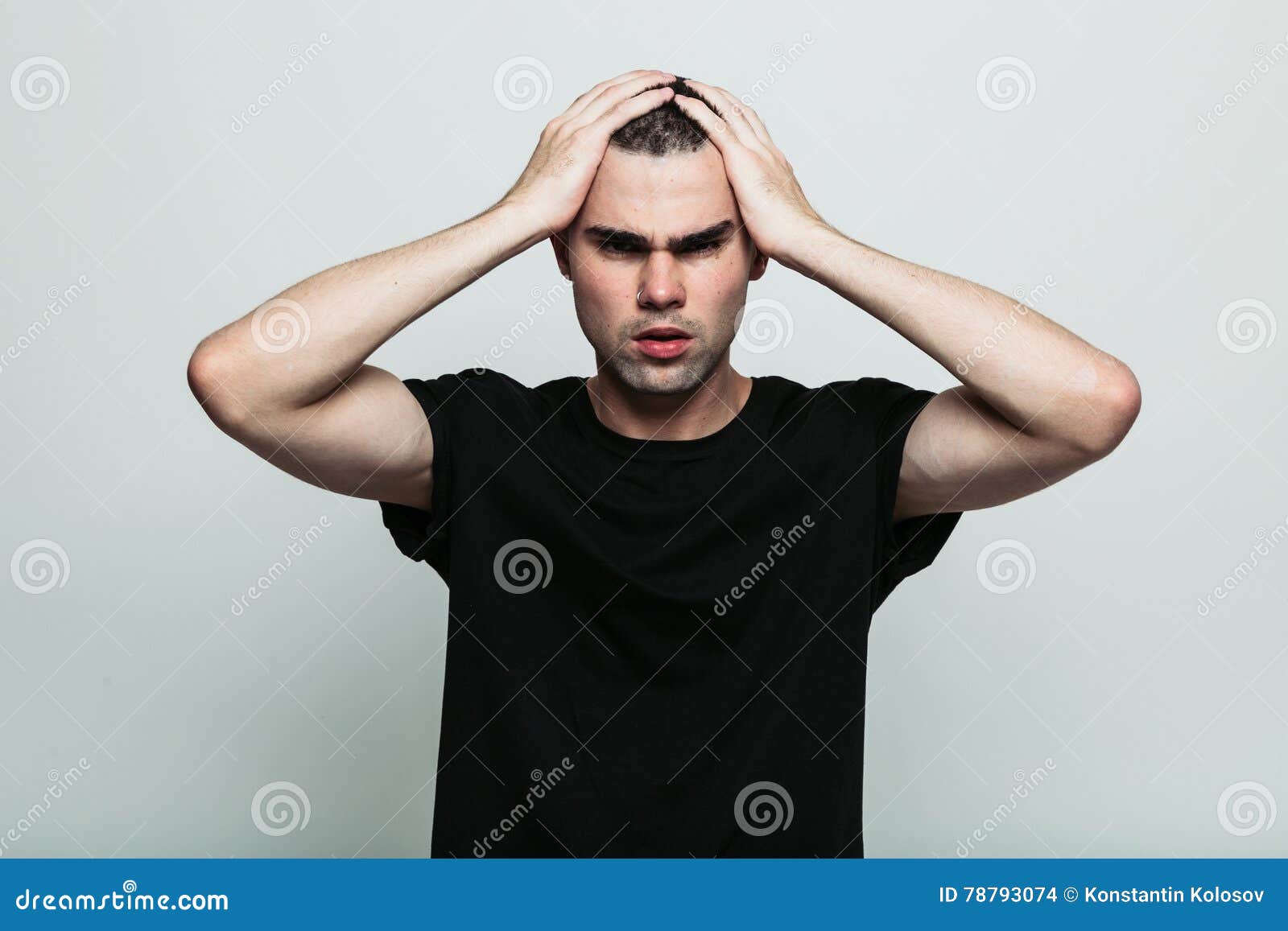 Worrying Man Posing at Studio with Arm on Head Stock Photo - Image of ...