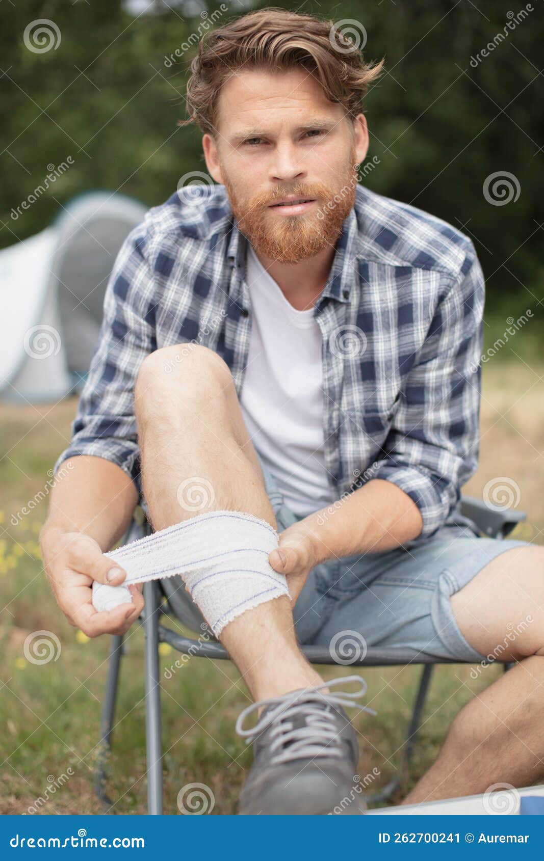 Wounded Man Bandaging Leg while on Camping Stock Image - Image of adult ...