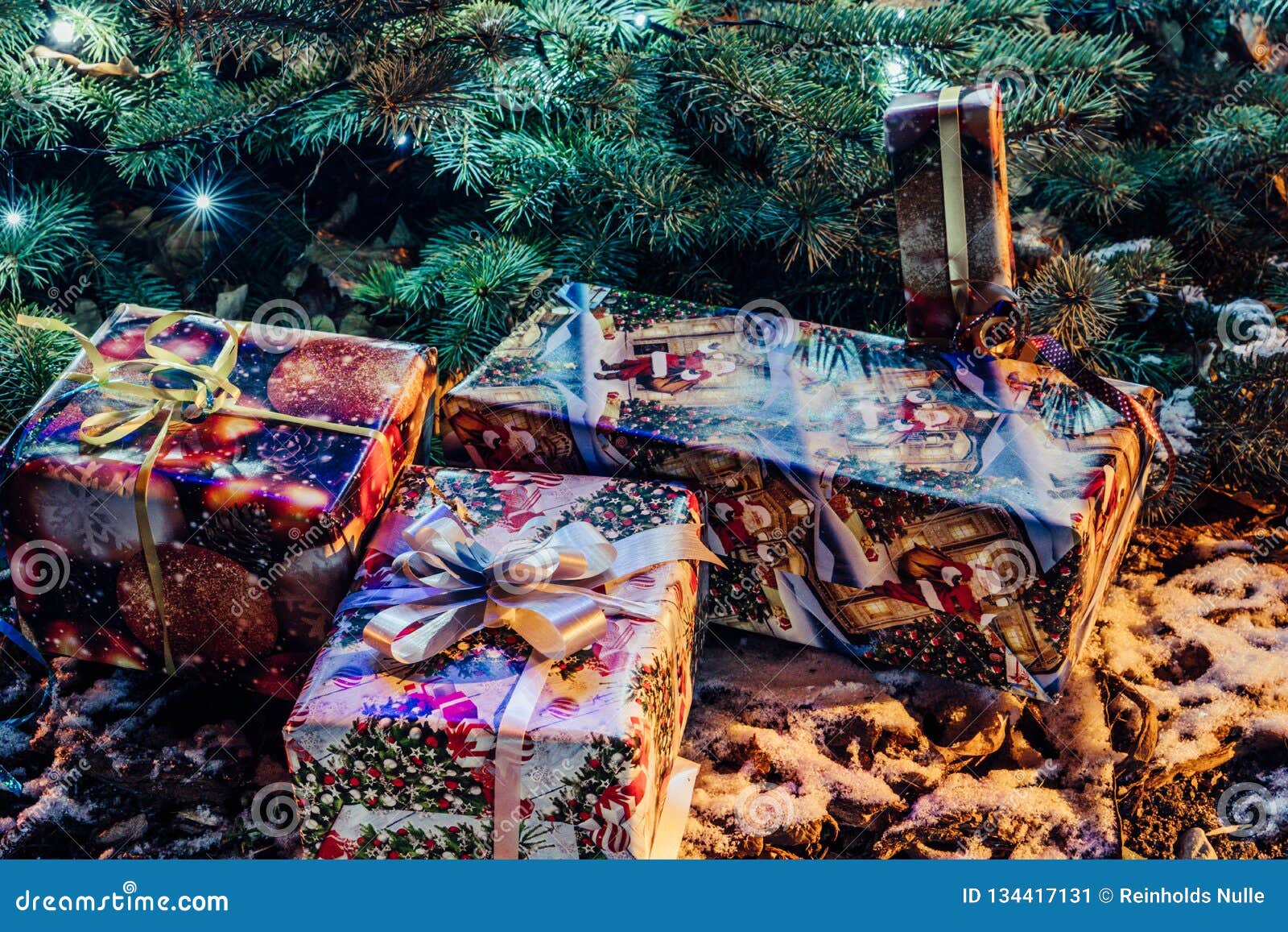 Wrapped Christmas Presents Under the Christmas Tree with Lights Stock ...