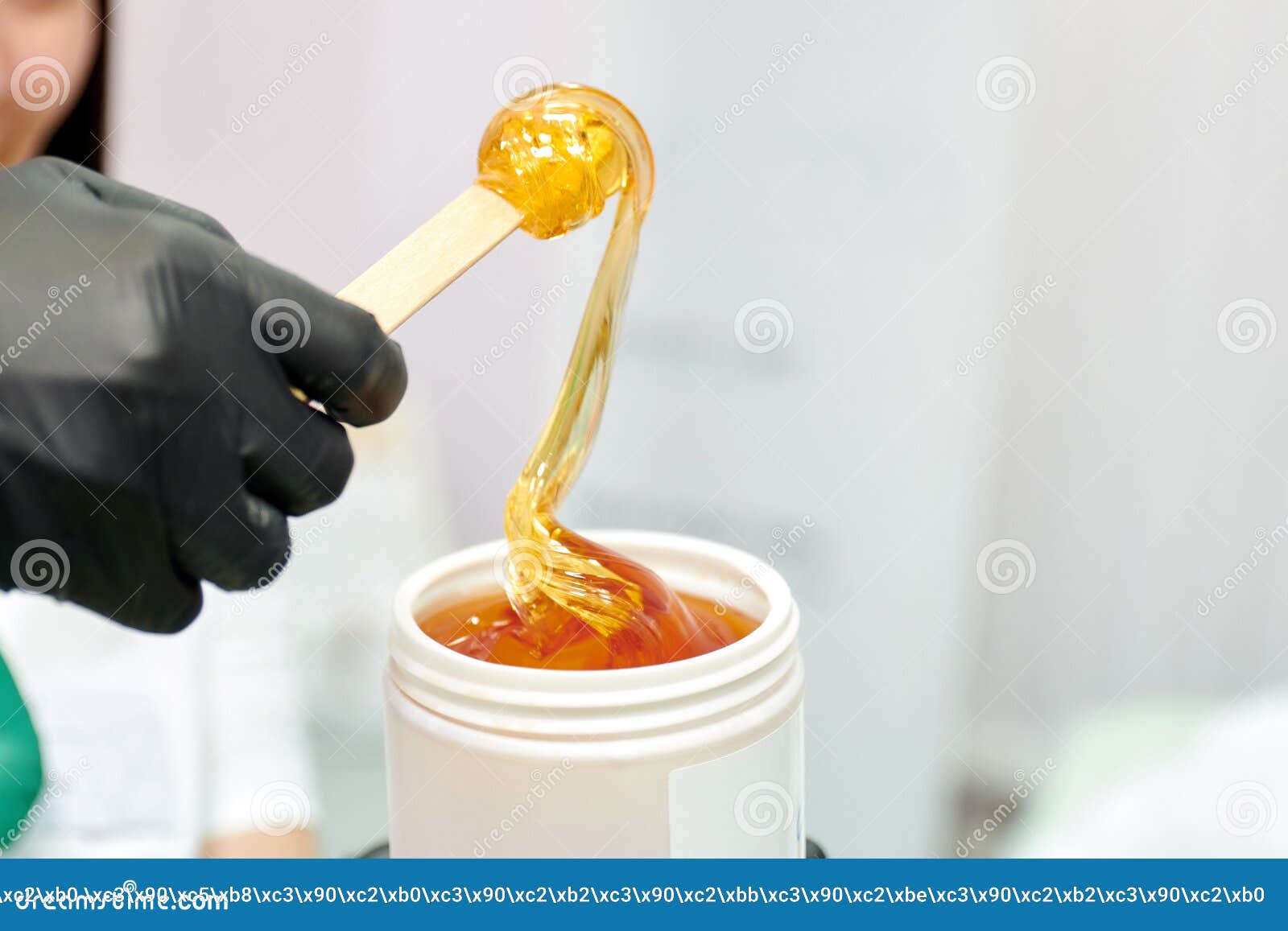 Wrapping Sugar Paste for Sugaring from a White Jar on a Wooden Spatula ...