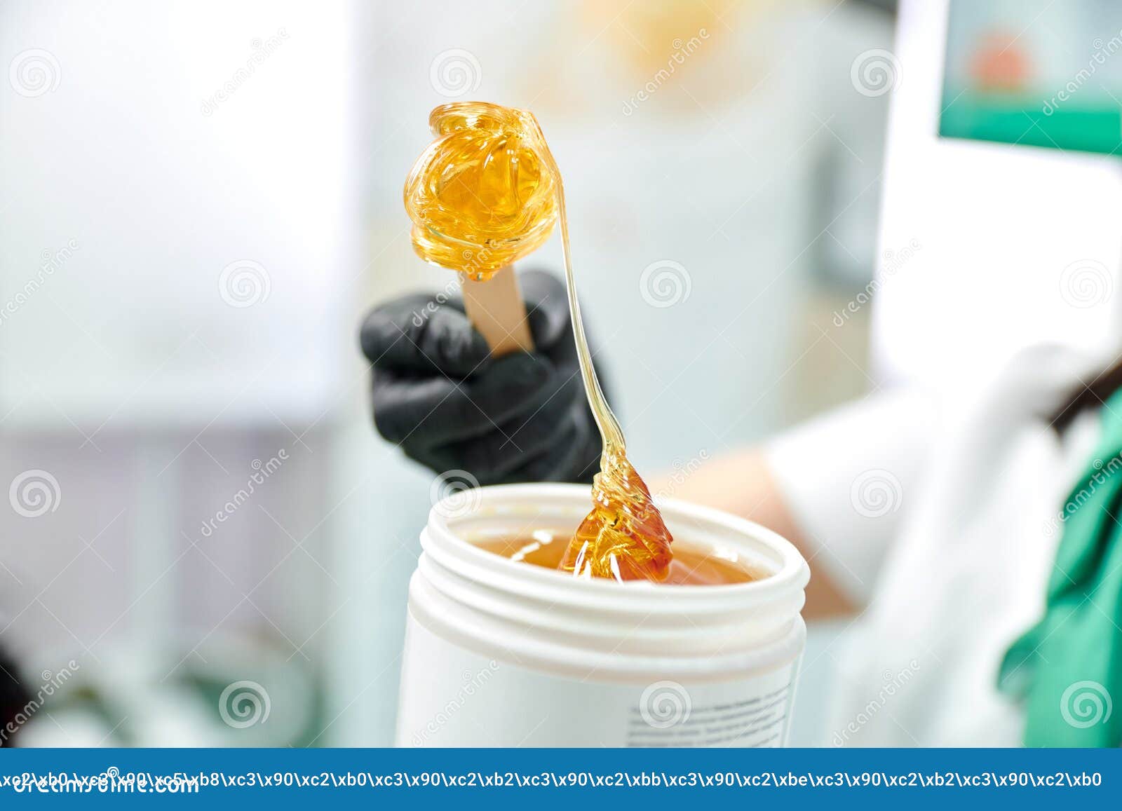 Wrapping Sugar Paste for Sugaring from a White Jar on a Wooden Spatula ...