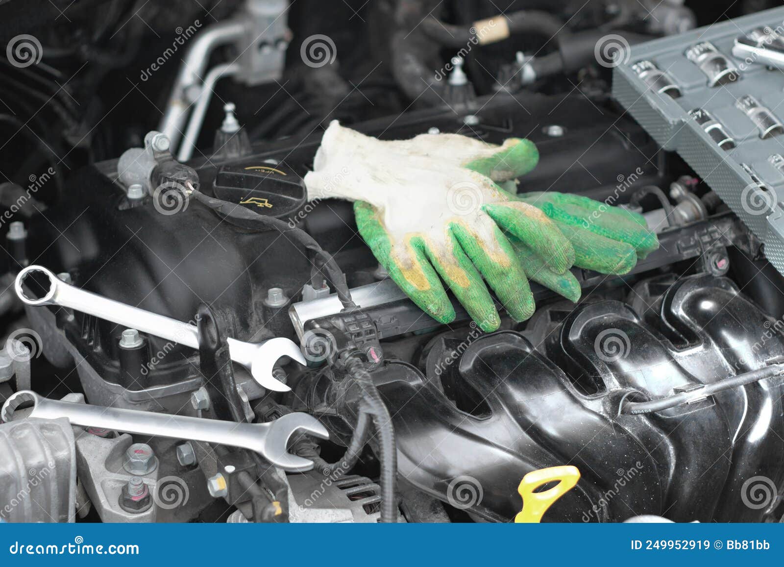 Repair Wrenches and Work Gloves Lie on the Car Engine in the Engine ...