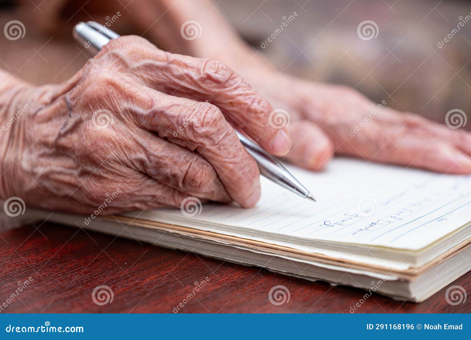 Wrinkled Hands for Elderly Person Writing Notes on His Note Book Stock ...