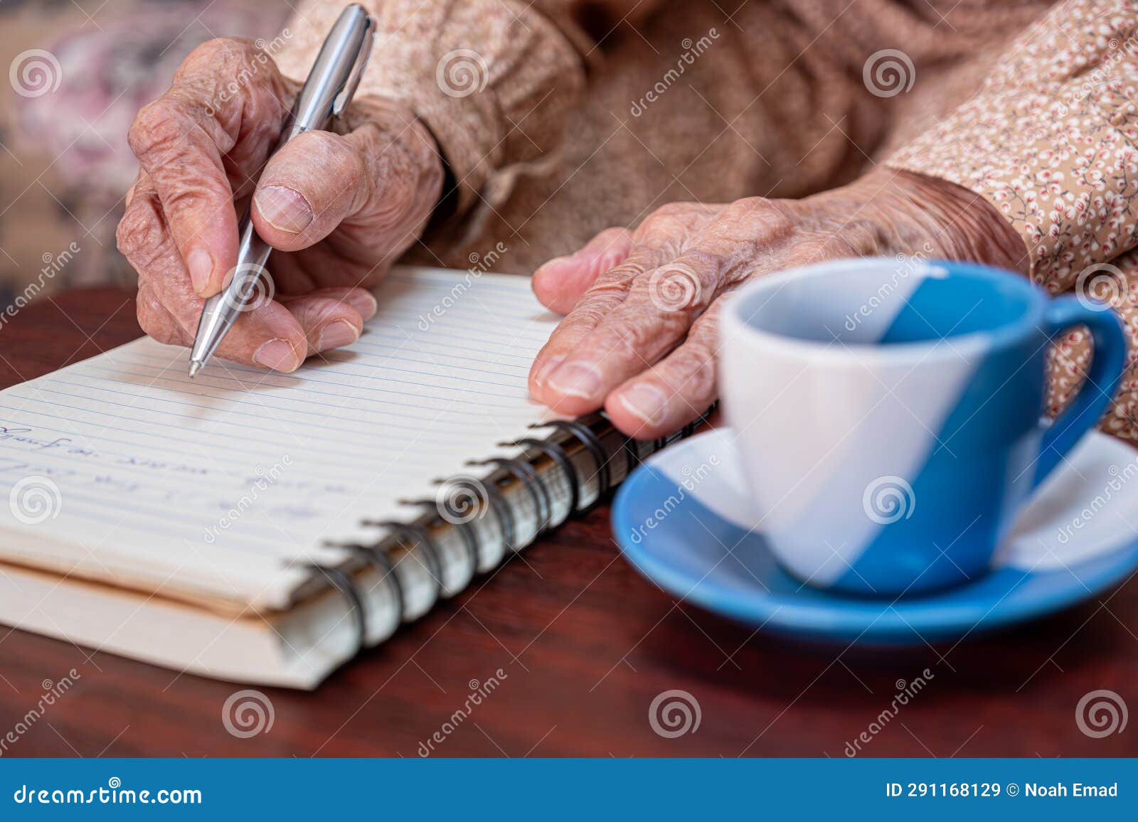 Wrinkled Hands for Elderly Person Writing Notes on His Note Book while ...