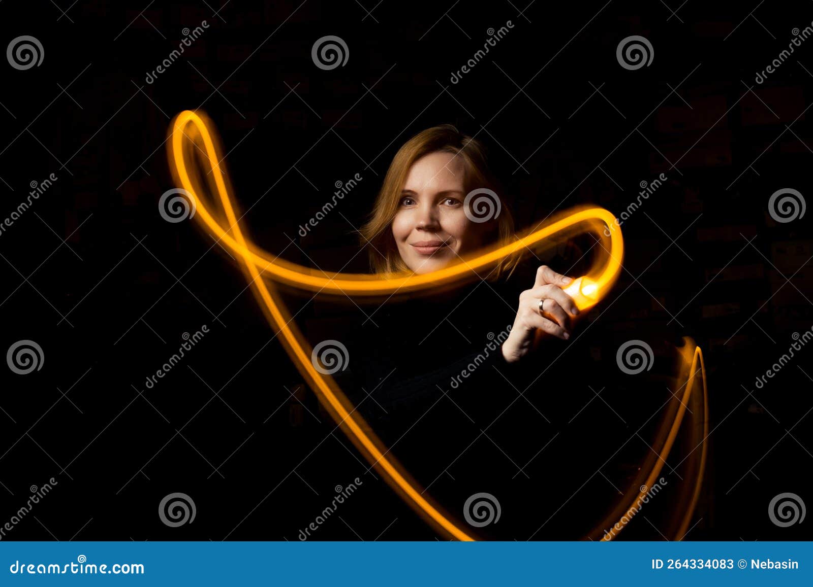 Write with Light at Long Exposure in the Dark. a Middle-aged Woman ...