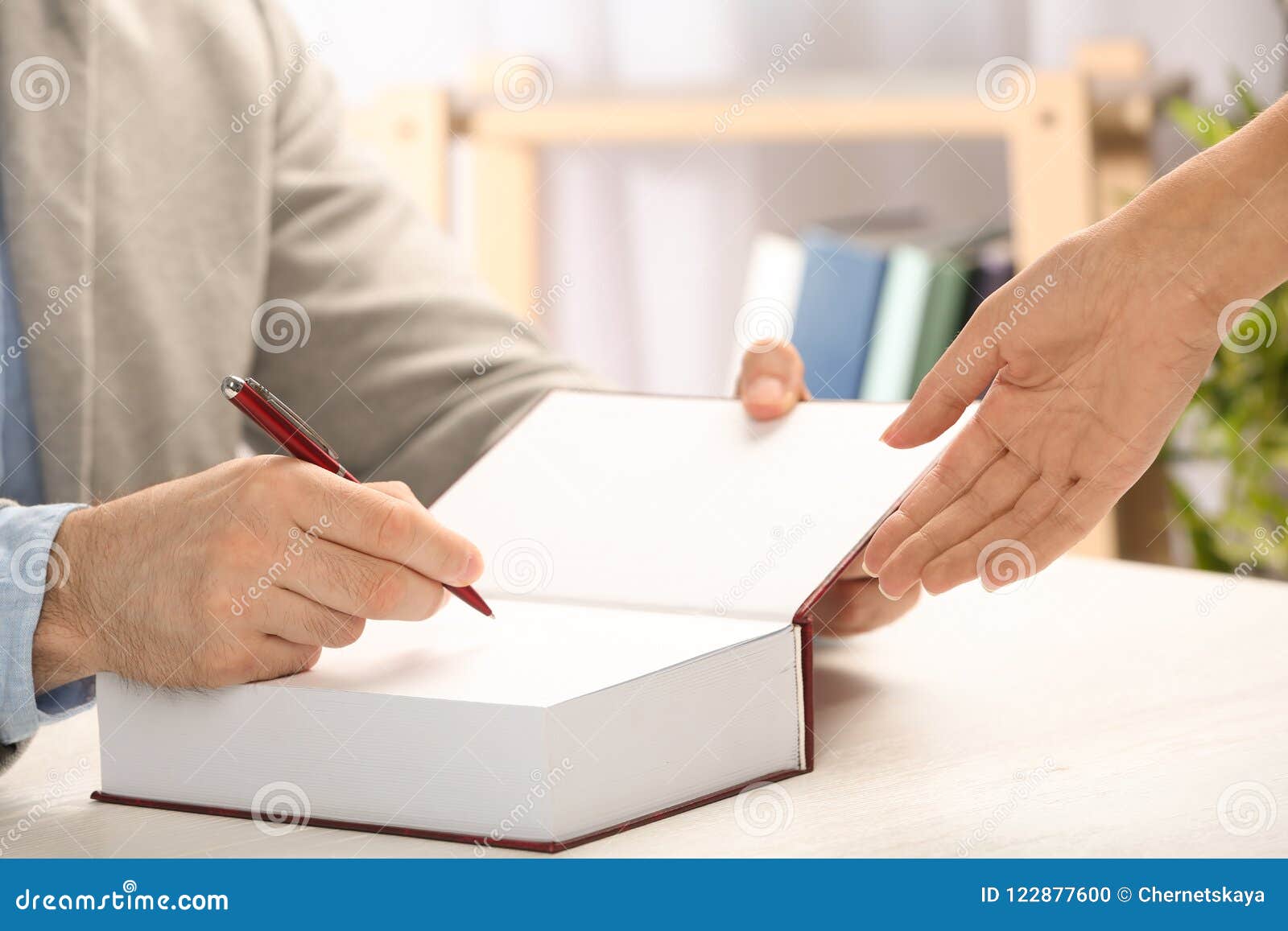 Writer Signing Autograph in Book at Table Stock Photo - Image of ...