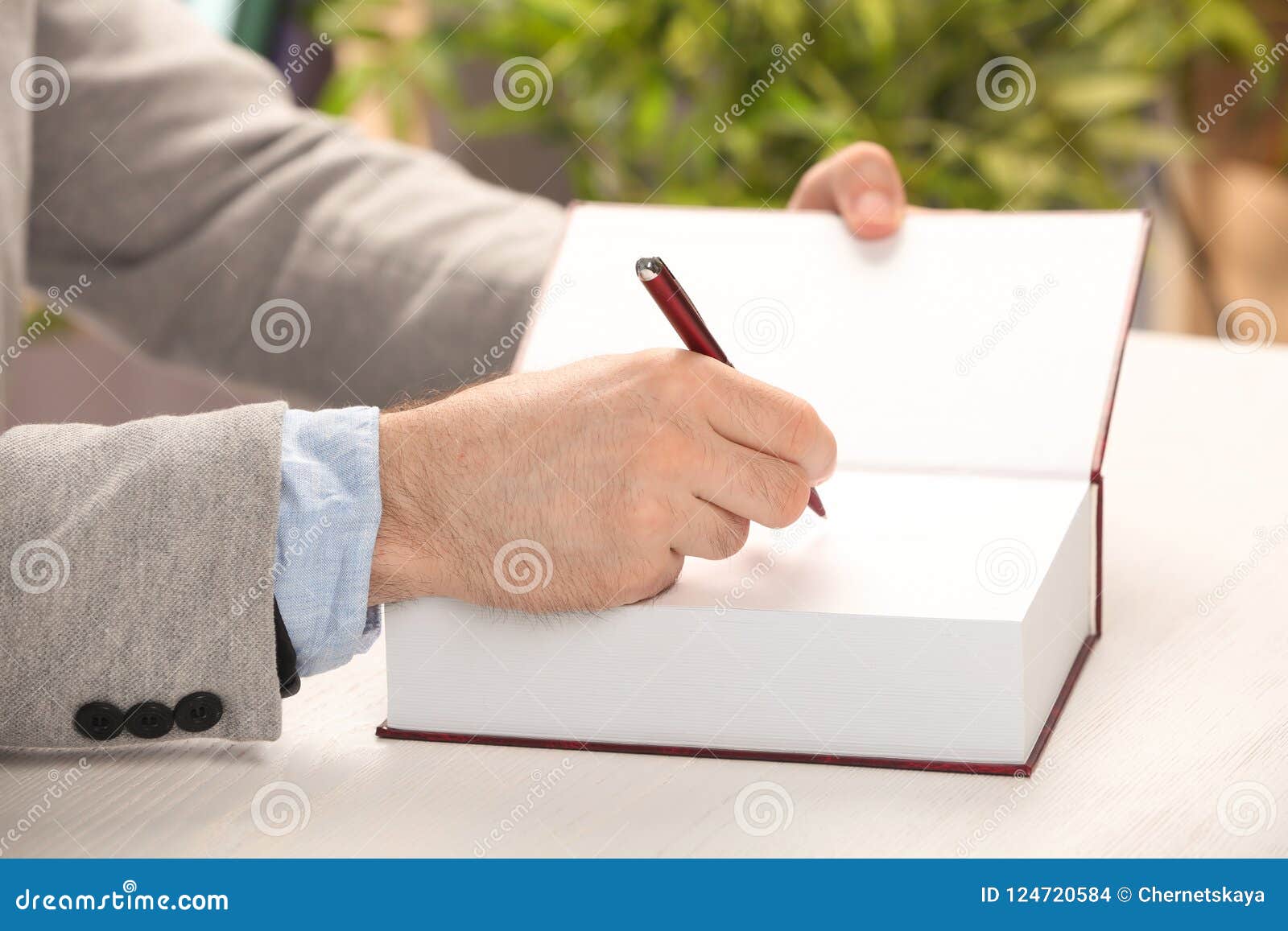 Writer Signing Autograph in Book at Table Stock Photo - Image of novel ...