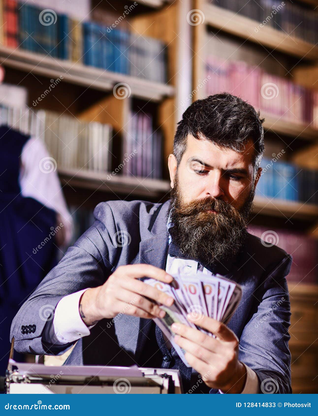 Writer with Strict Face with Typewriter in Library with Books Stock ...