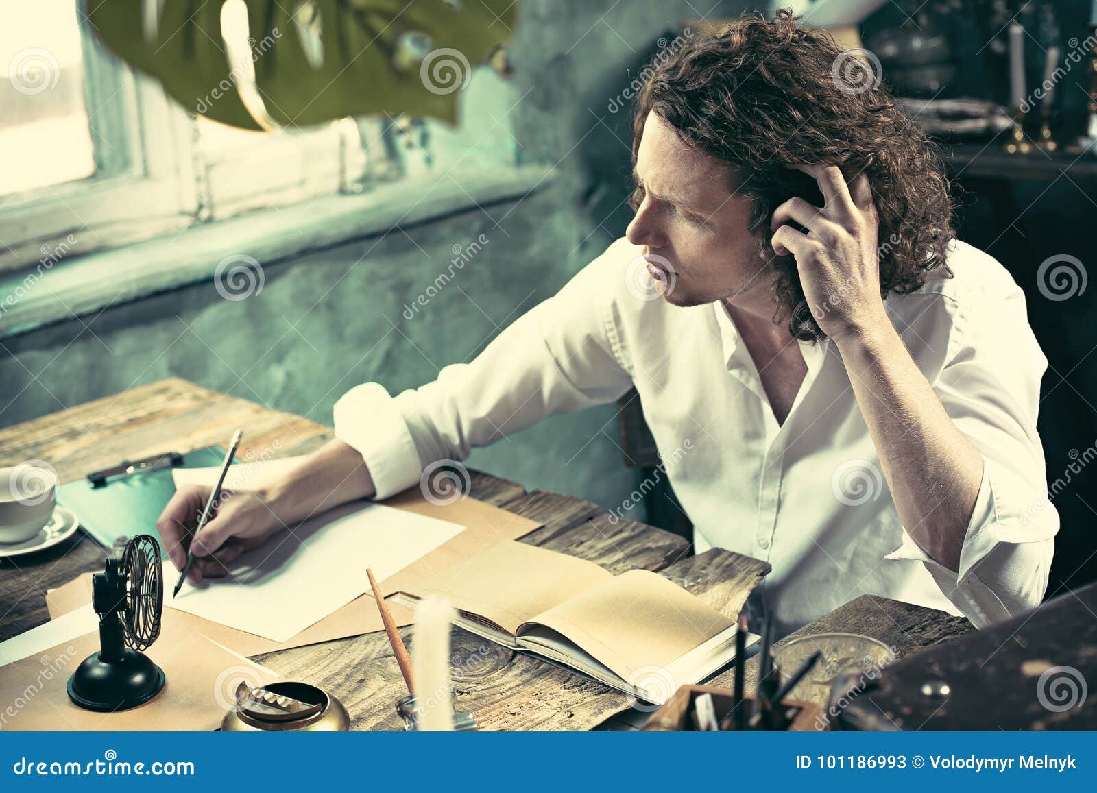 Writer at Work. Handsome Young Writer Sitting at the Table and Writing ...