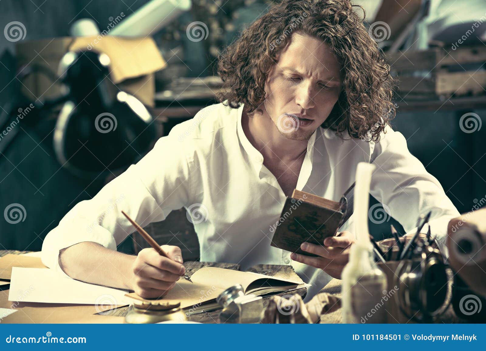 Writer at Work. Handsome Young Writer Sitting at the Table and Writing ...
