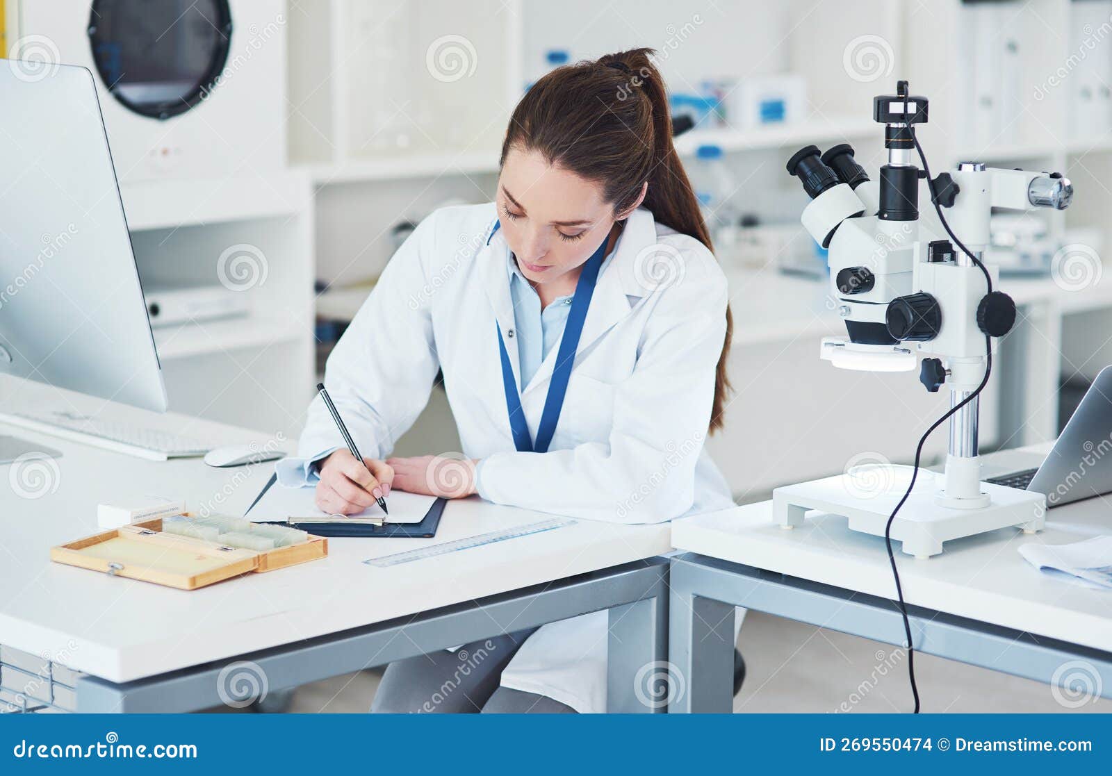 Writing Down My Findings. a Focused Young Female Scientist Making Notes ...