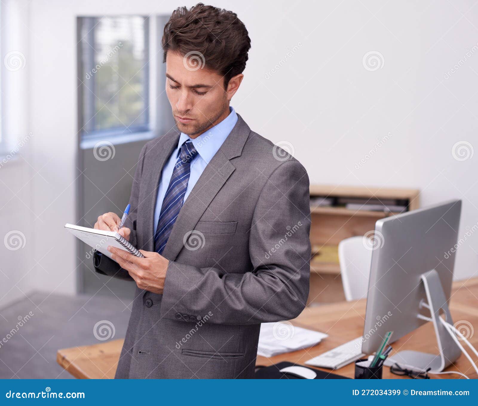Writing His Ideas Down. a Handsome Businessman Taking Notes at His Desk ...