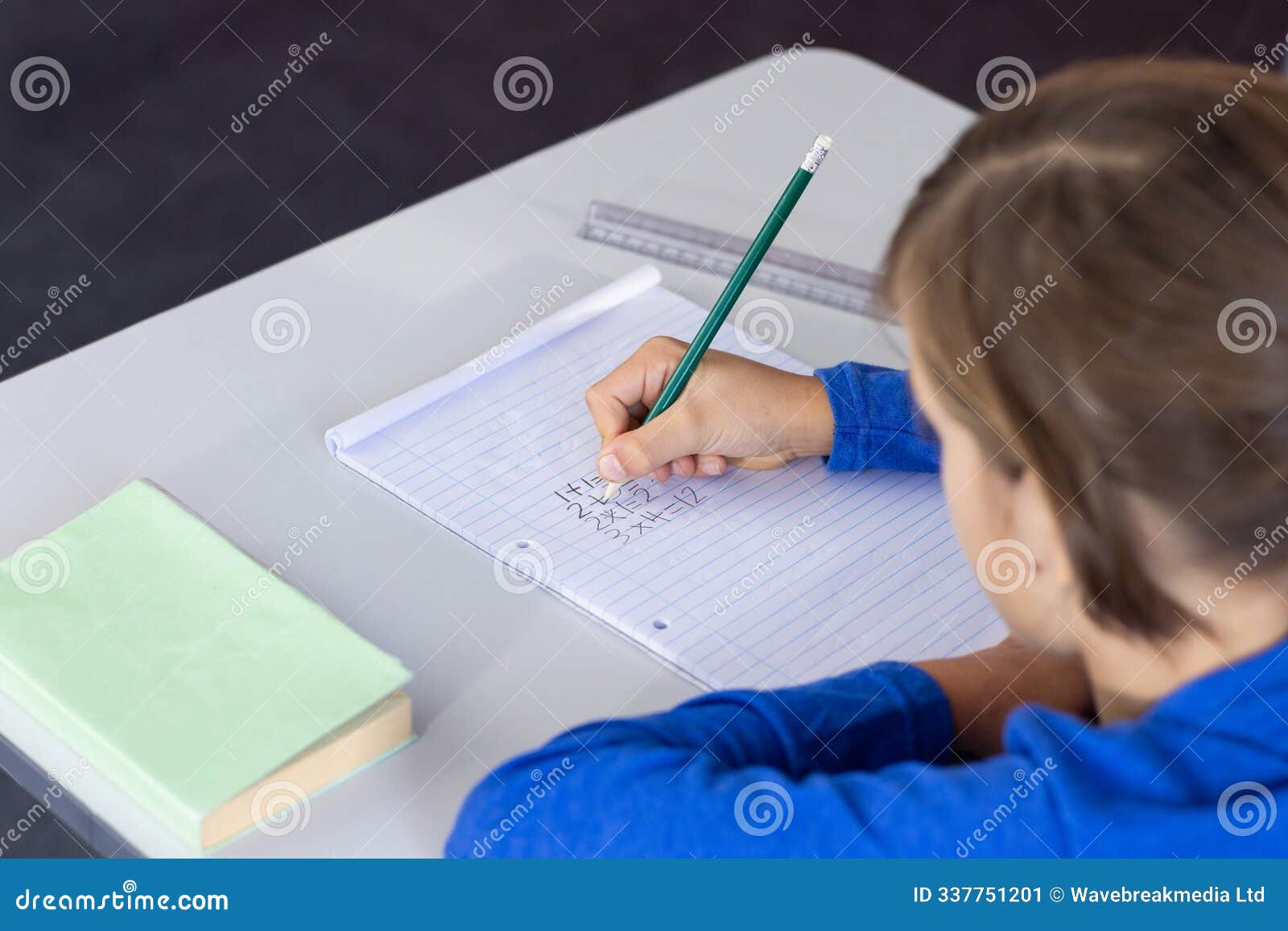 Writing Math Equations in Notebook, Boy Focusing on Schoolwork at Desk ...