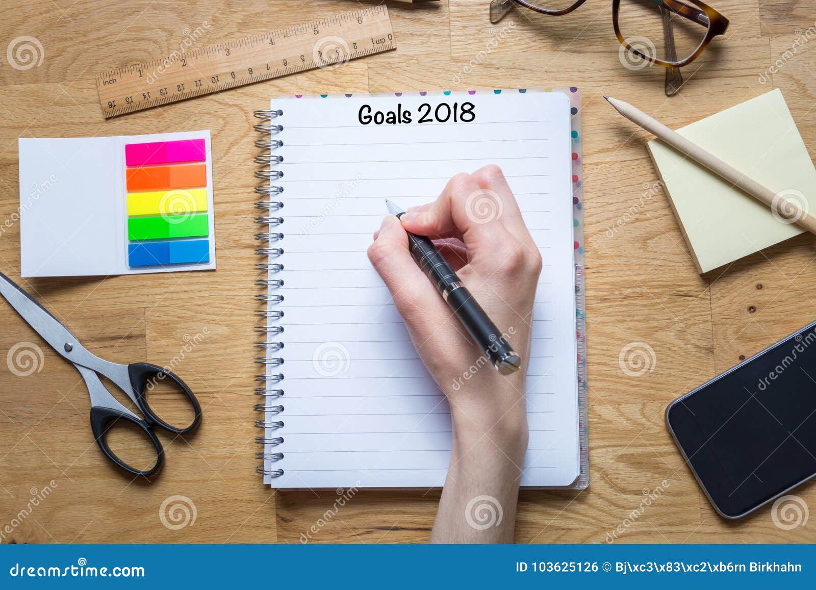 Writing on Notepad with Goals for 2018 and Pen and Other Accessories on ...