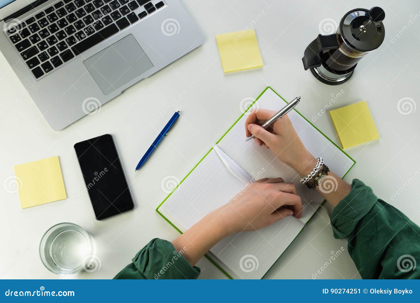 Writing in Notepad Sitting at Desk with Smartphone and Laptop Com Stock ...