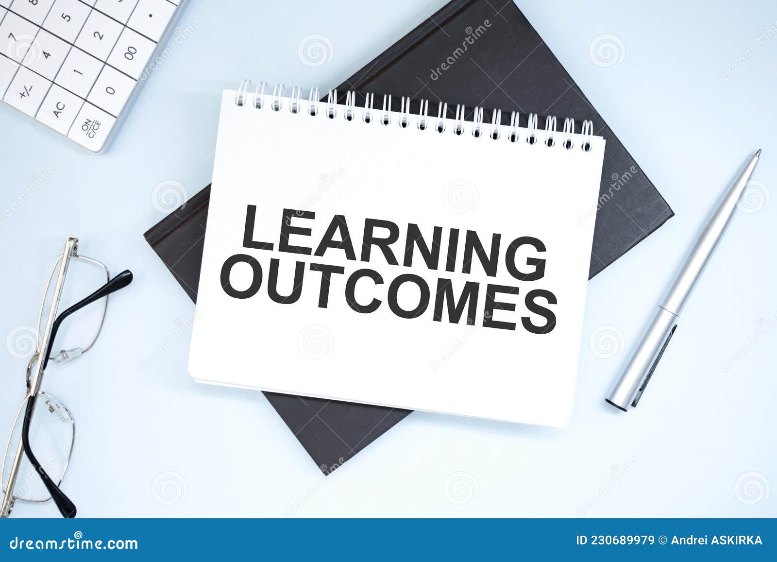 Writing Text Showing Learning Outcomes. Calculator,pen,plan,glasses and ...