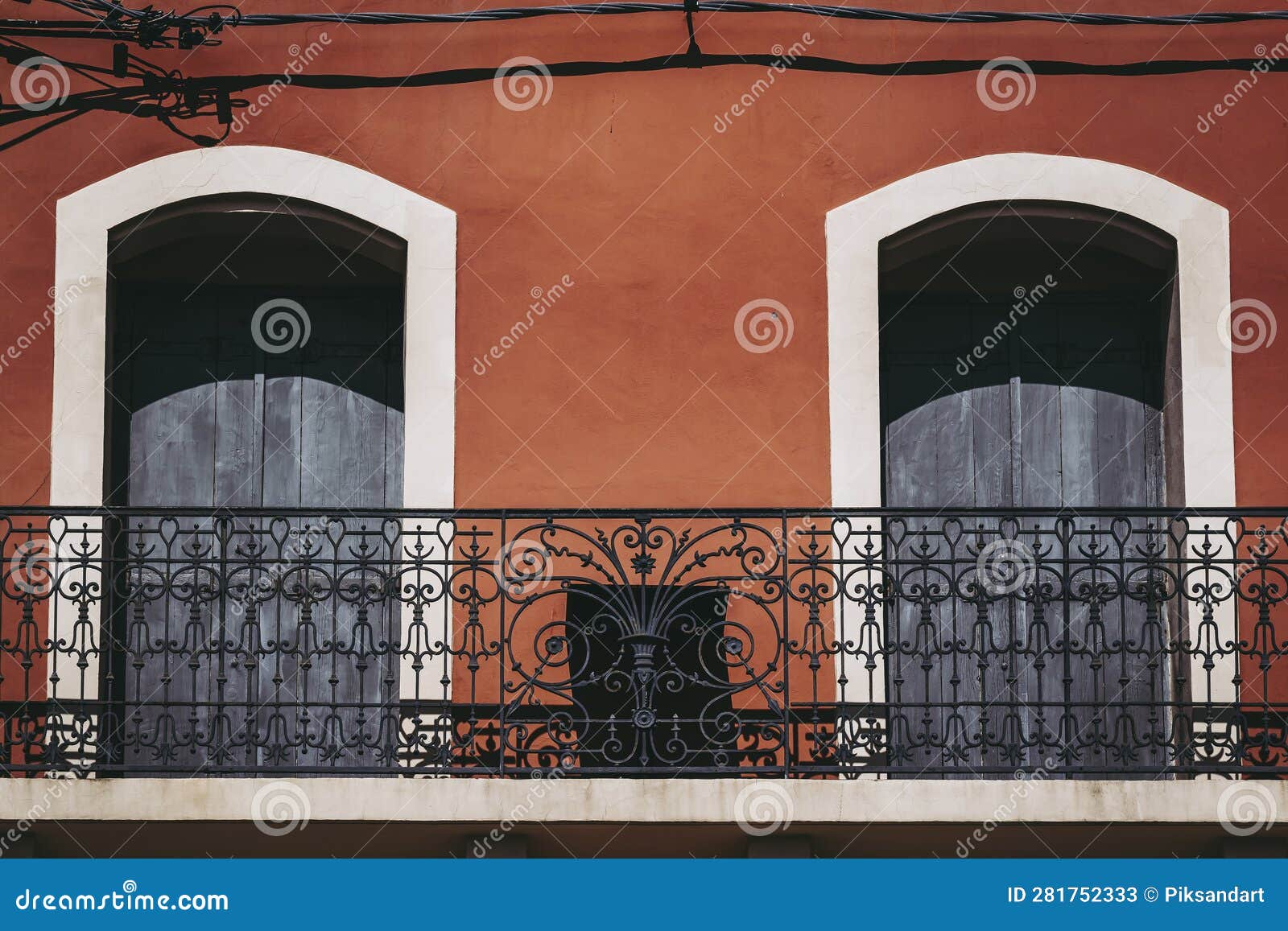 Wrought Iron Balcony of a House with Colored Plaster and Two Closed ...