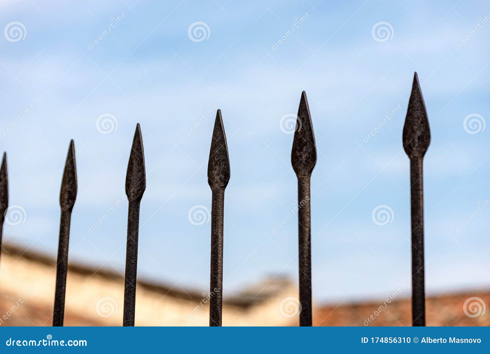 Wrought Iron Fence with Sharp Points on Blue Sky with Clouds Stock ...