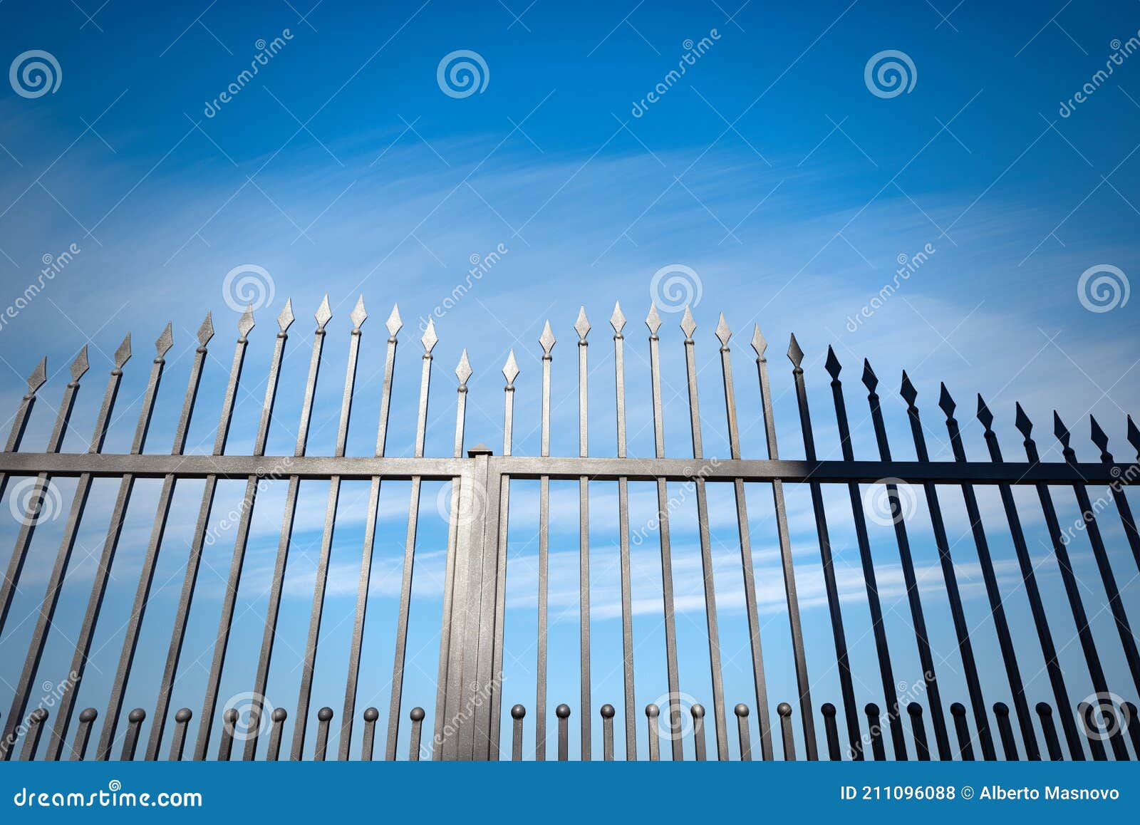 Wrought Iron Gate with Sharp Points on Blue Sky with Clouds Stock Photo ...