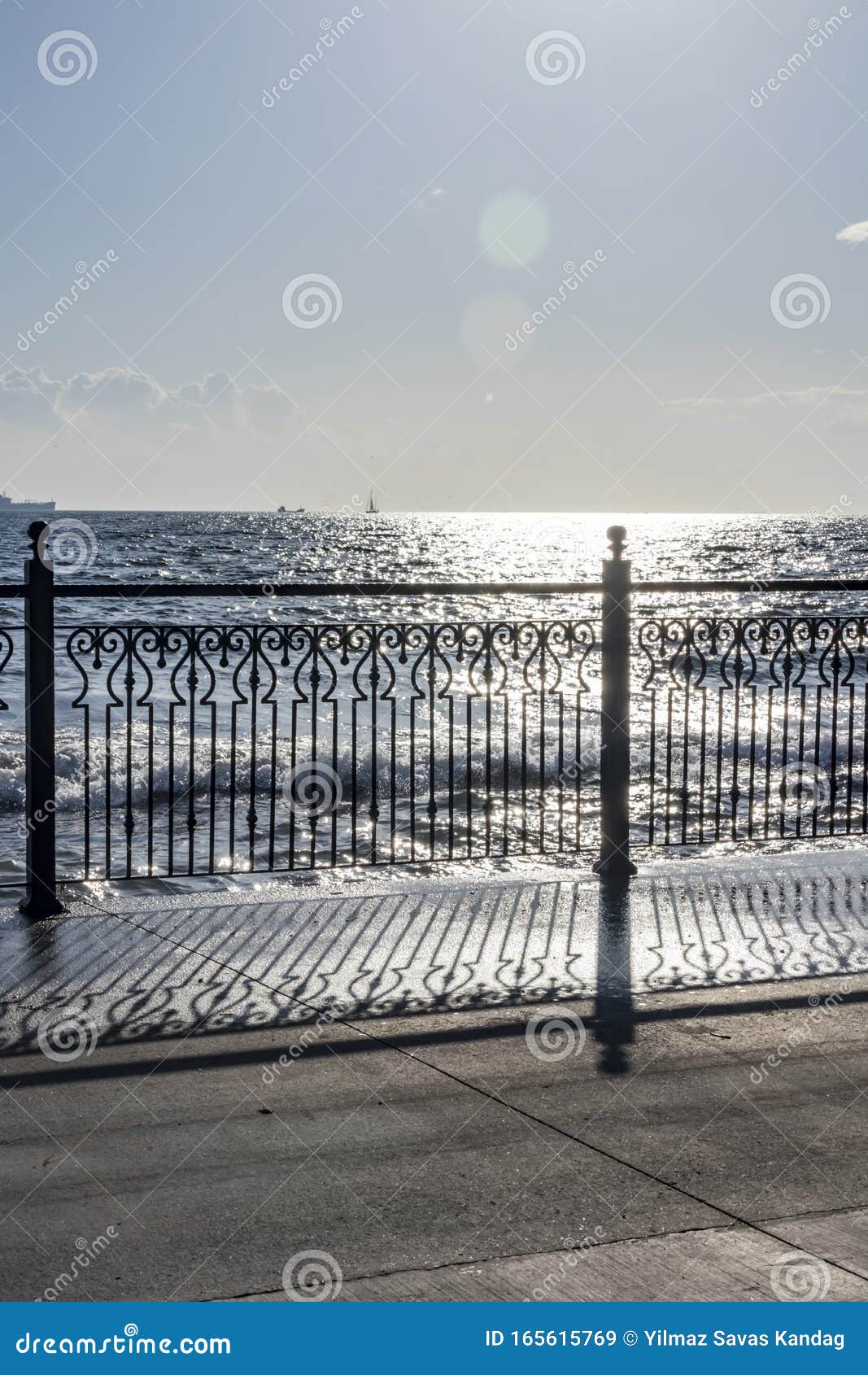 Wrought Iron Railing at the Pier and Shadows with Sunlight and Waves ...