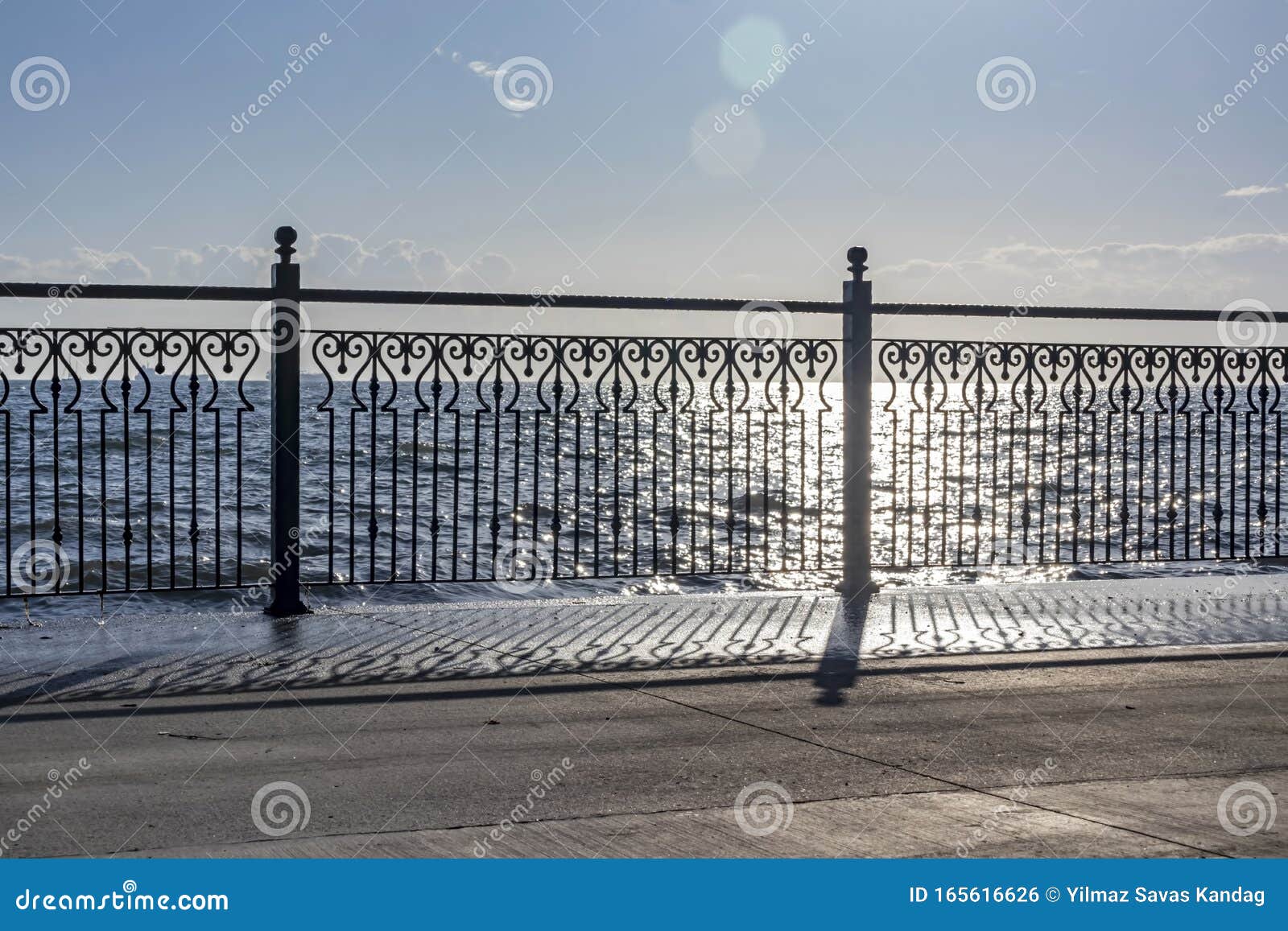 Wrought Iron Railing at the Pier and Shadows with Sunlight and Waves ...