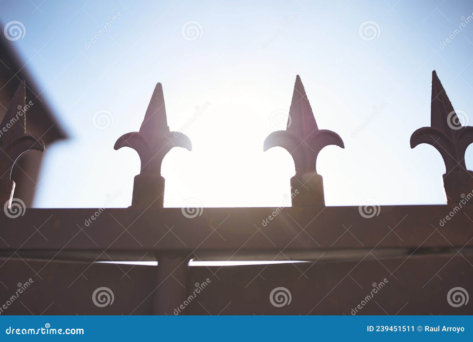 Wrought Iron Spikes on a Gate with the Sun in the Background Stock ...