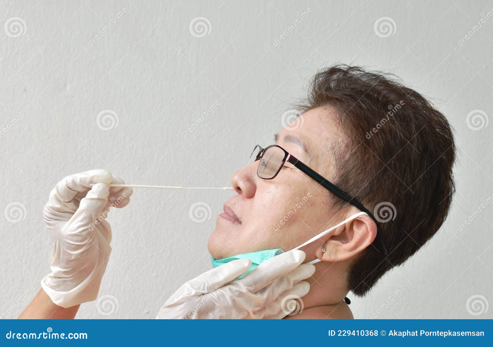 Elder Woman Wearing Eye Glasses Testing by Hand in Glove Holding Cotton ...