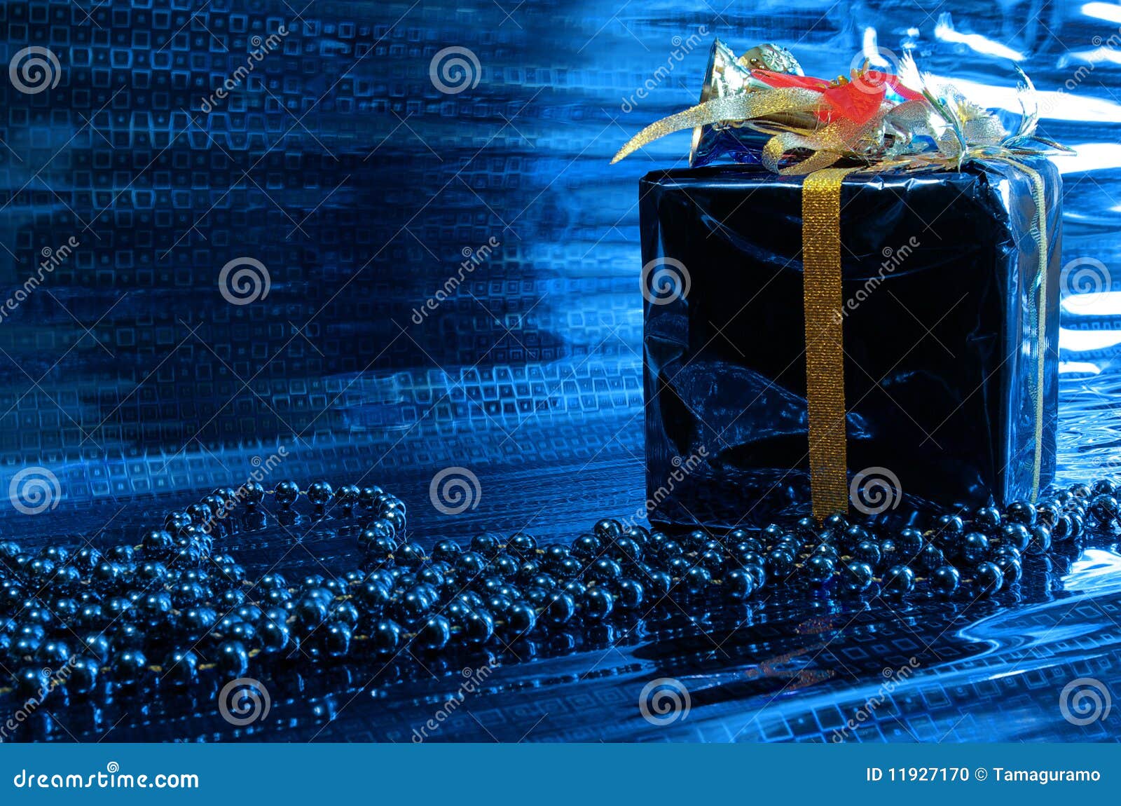 Xmas Blue Wrapped Present and Beads on Blue Stock Photo - Image of ...
