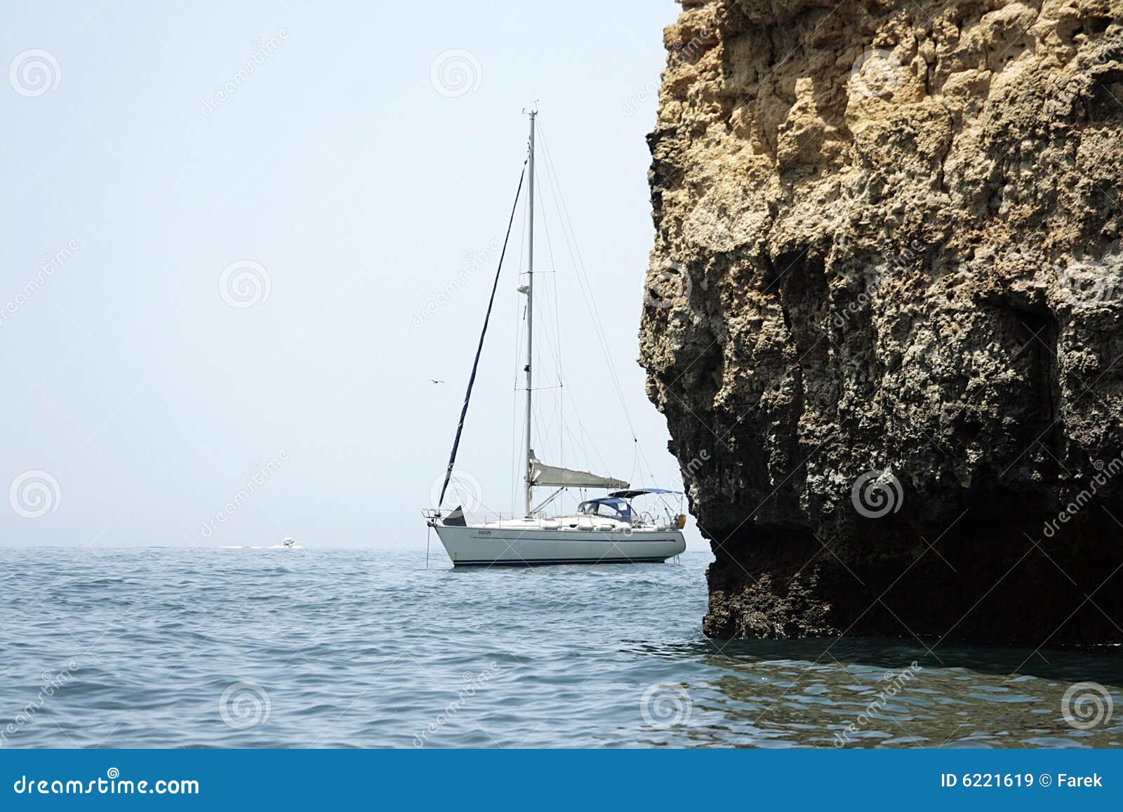 Yacht sailing by cliff stock image. Image of rocks, rocky - 6221619