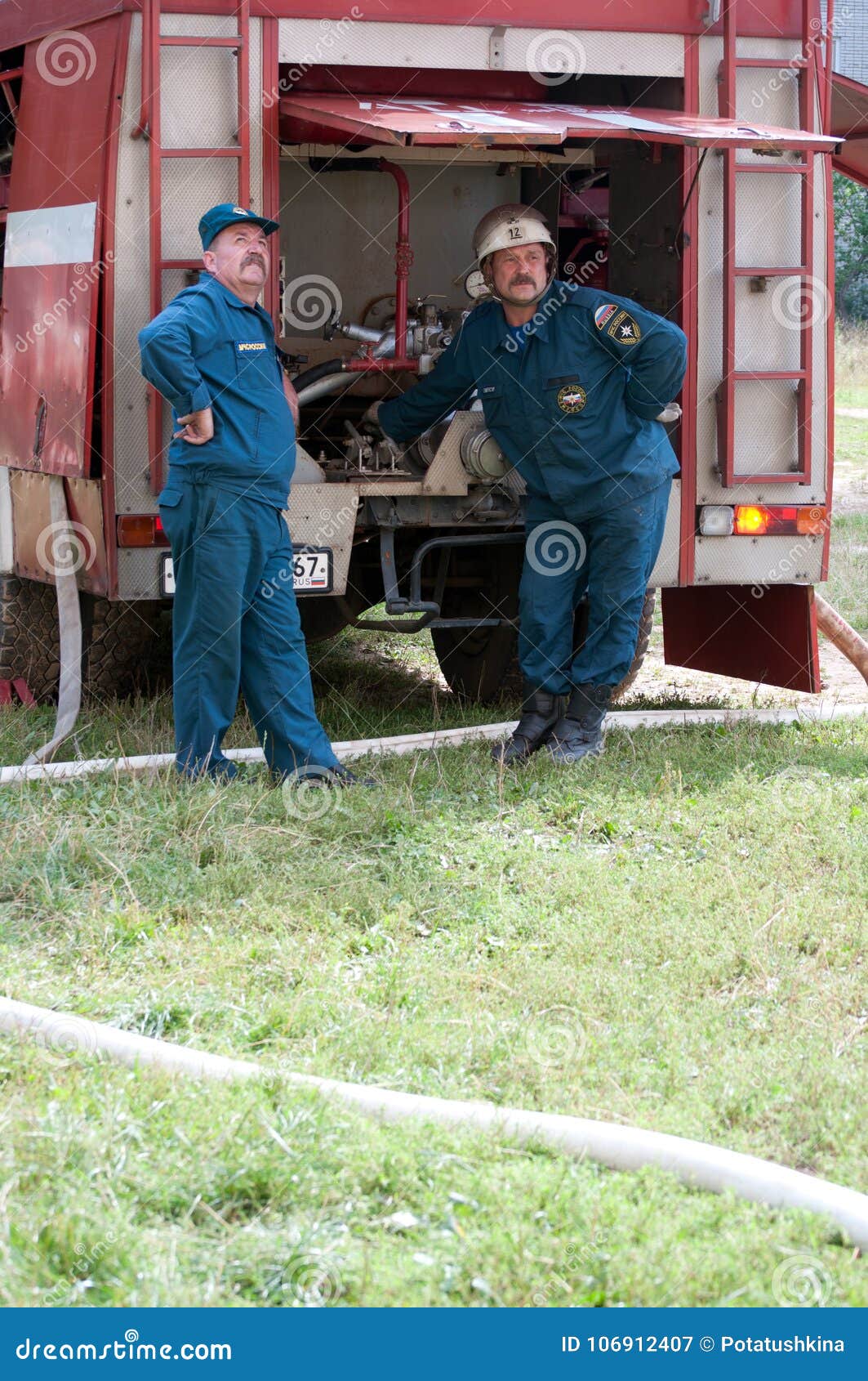 Two Firemen Stand by the Fire Engine and Look Up Editorial Photography ...