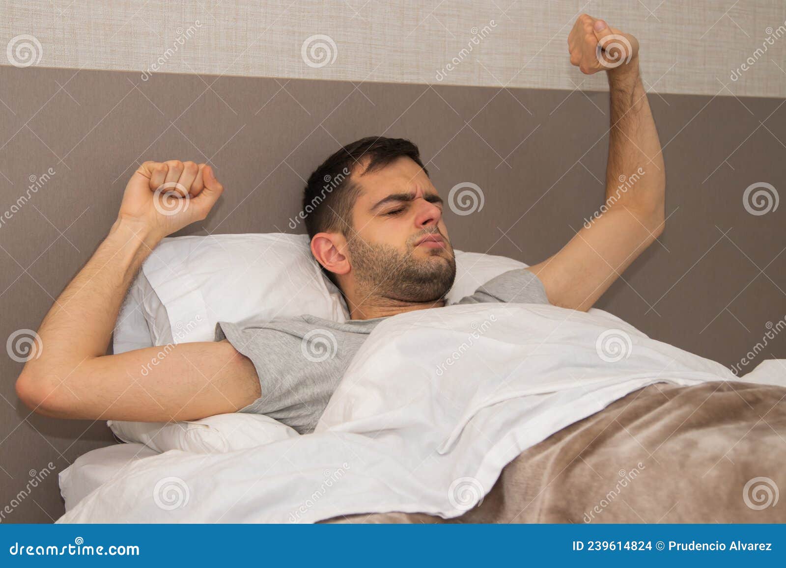 Man waking up in bed stock photo. Image of resting, male - 239614824