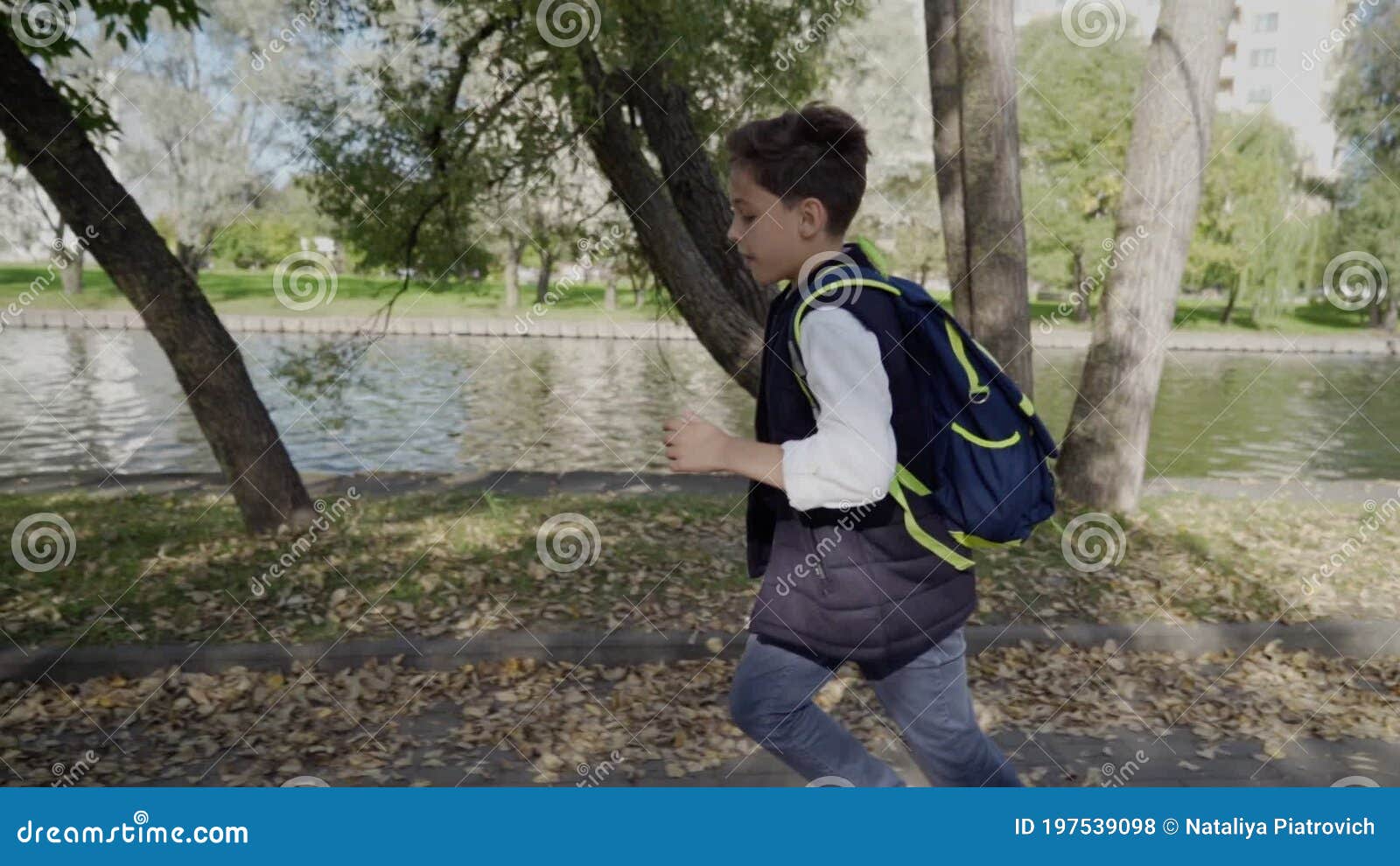 10 Year Caucasian Boy is Late for Classes at School. Boy is Running at ...