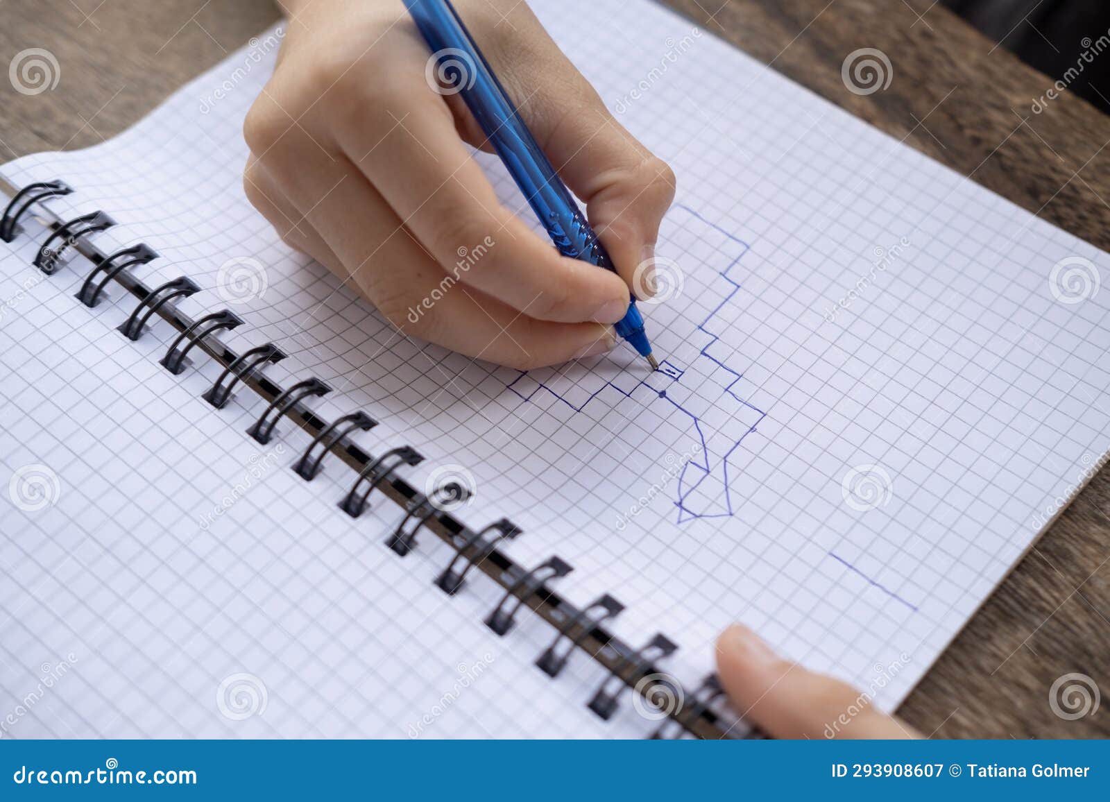 10-year-old Boy Drawing Graphic Dictation in Checkered Notebook, Moving ...