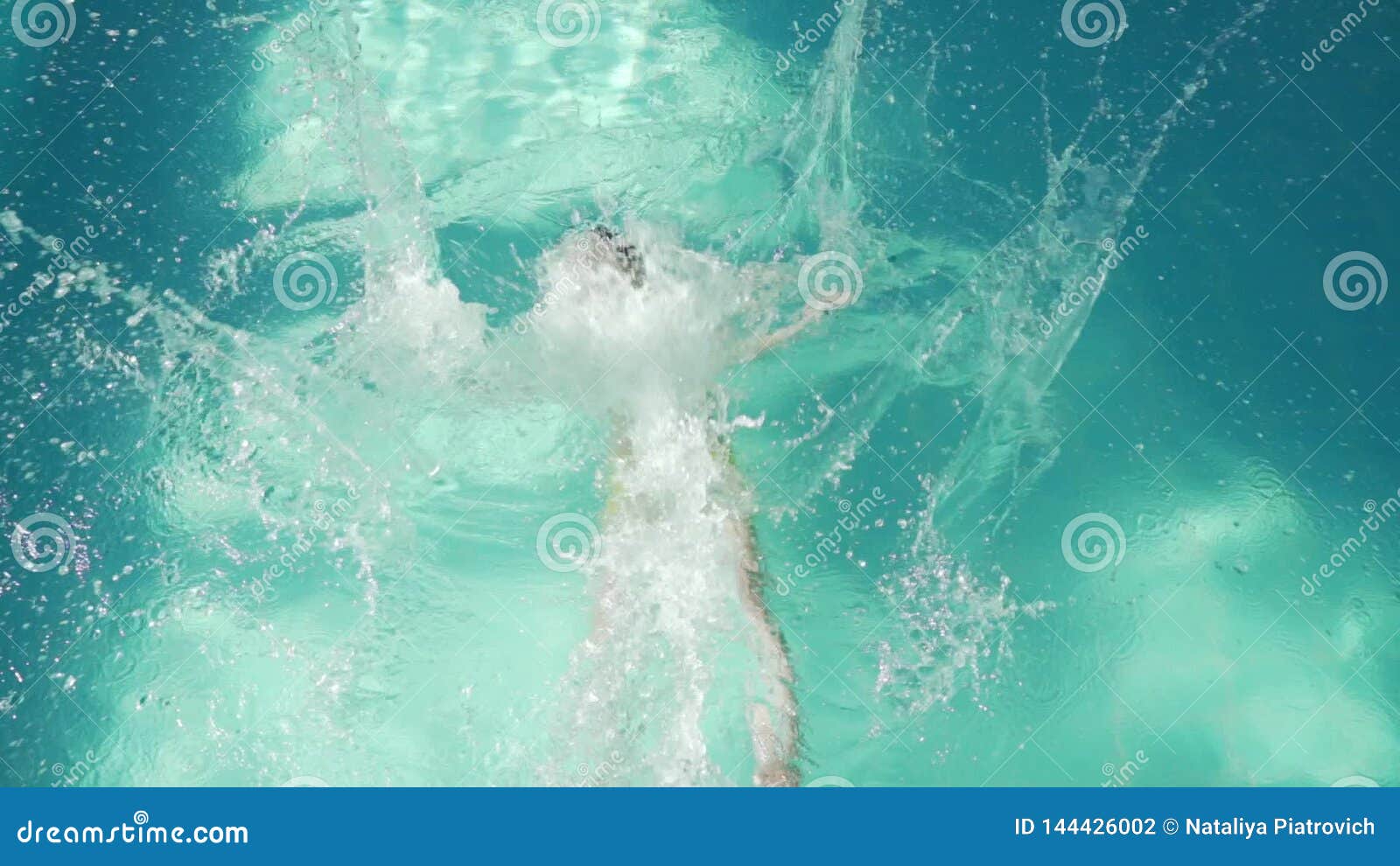 9 Year Old Boy Falling into the Pool with Blue Water. Splashes Fly in ...