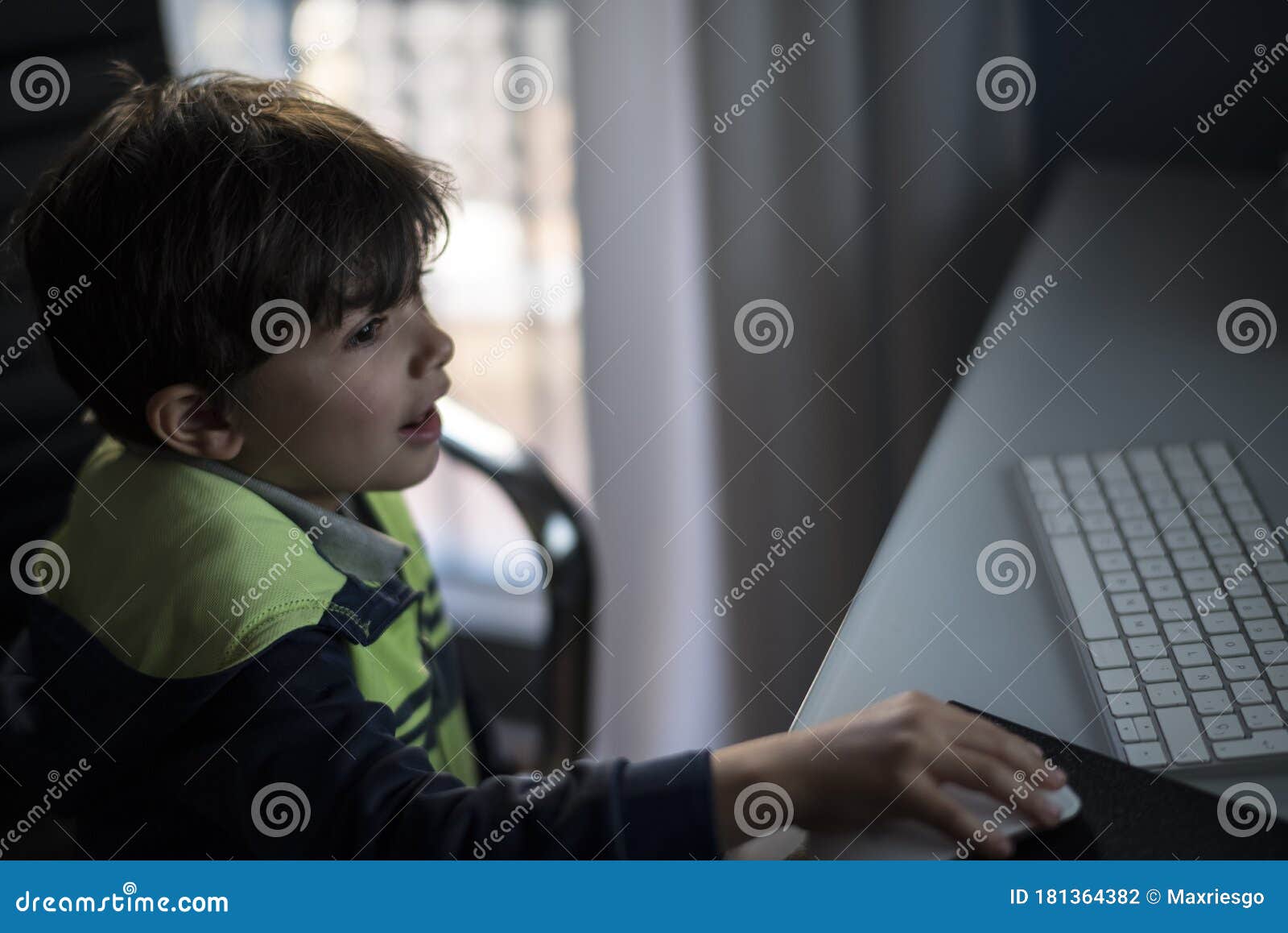 4 Year Old Boy Handles the Computer in a Dark Environment at Home Stock ...