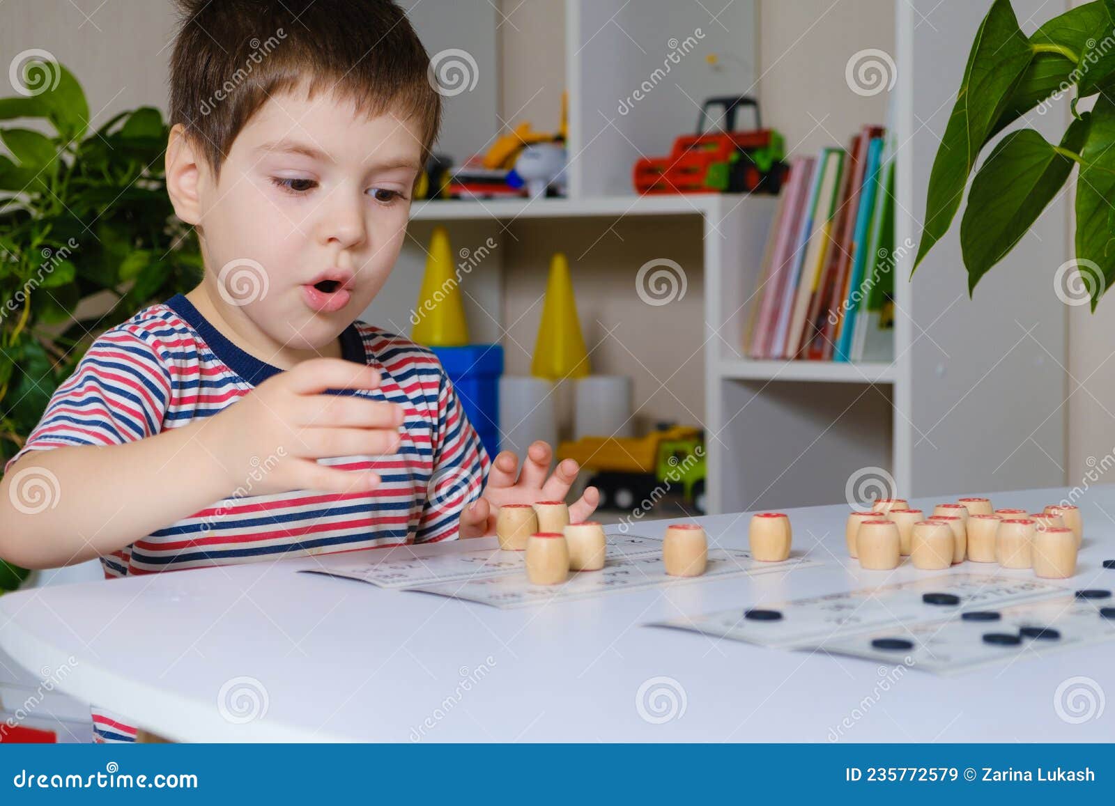 A 4-year-old Boy Plays Loto, Studies Numbers Using a Board Game. Stock ...