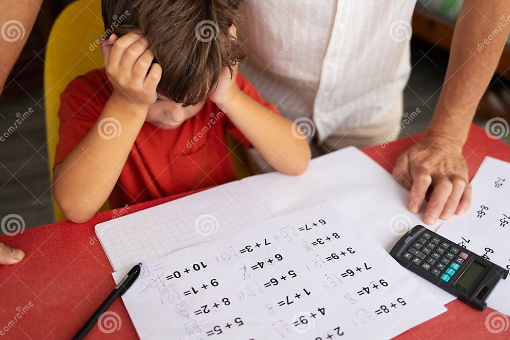 A 6-year-old Boy Sits in Front of a Sheet of Math Problems with Many ...
