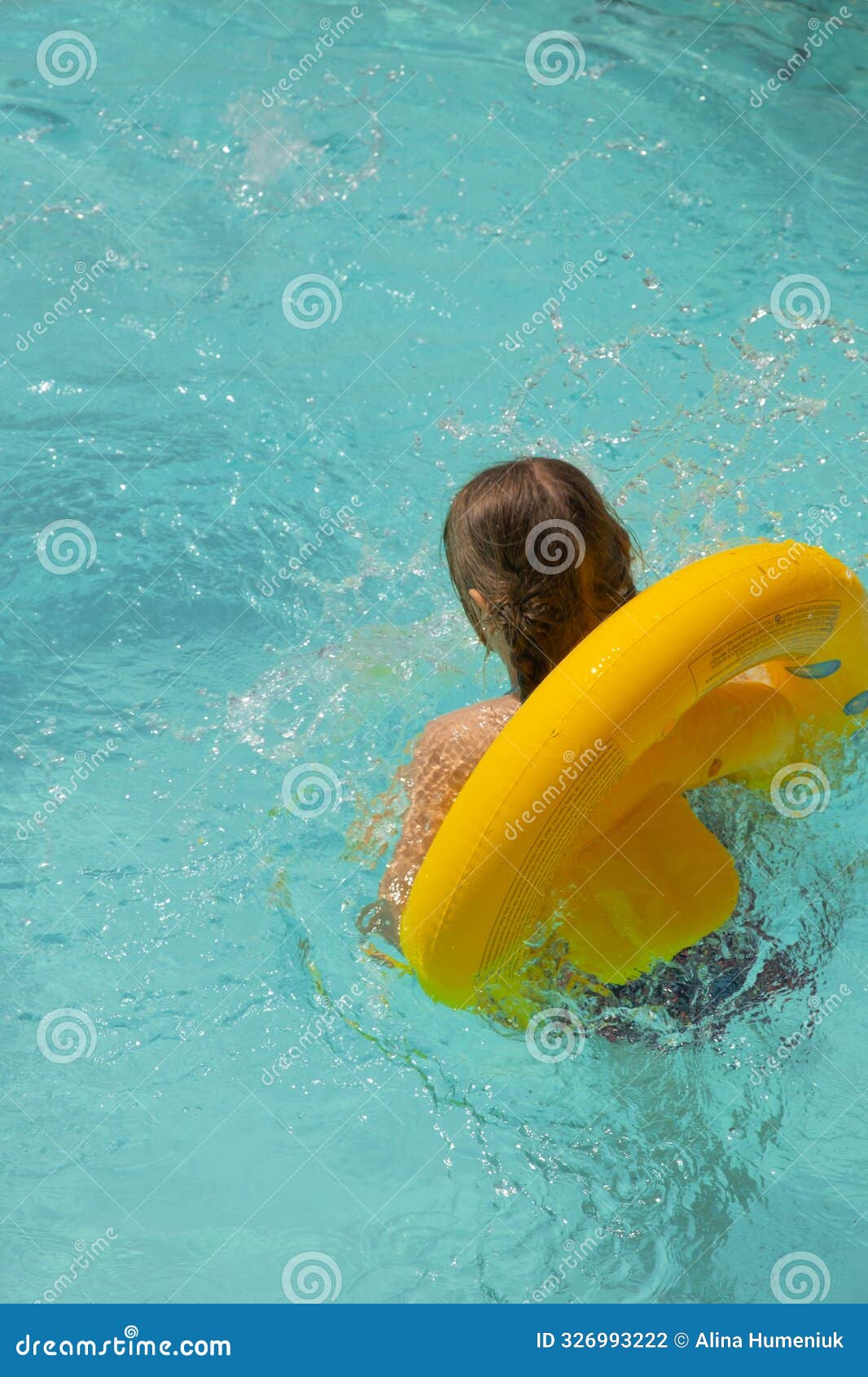 A 5-year-old Girl Swims in a Pool with an Inflatable Circle Stock Photo ...
