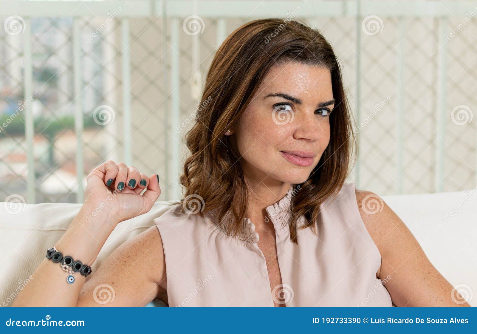 38 Year Old Woman In Her Home Office Sitting On The Couch And Looking