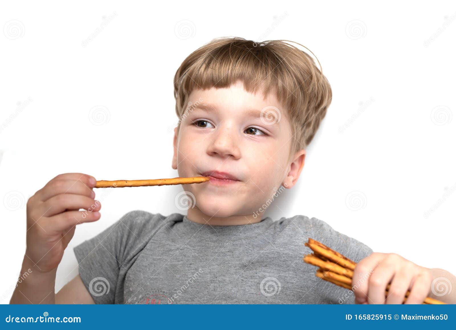 5 Years Old Boy Eats Bread Sticks on White Background, Crispy Snack ...