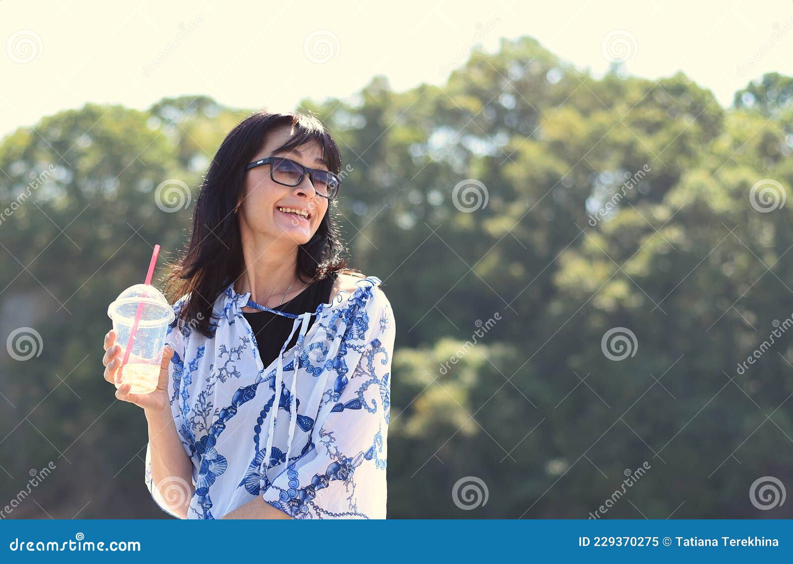45 Years Old Russian Woman Drinking Lemonade And Sitting On Pier Stock