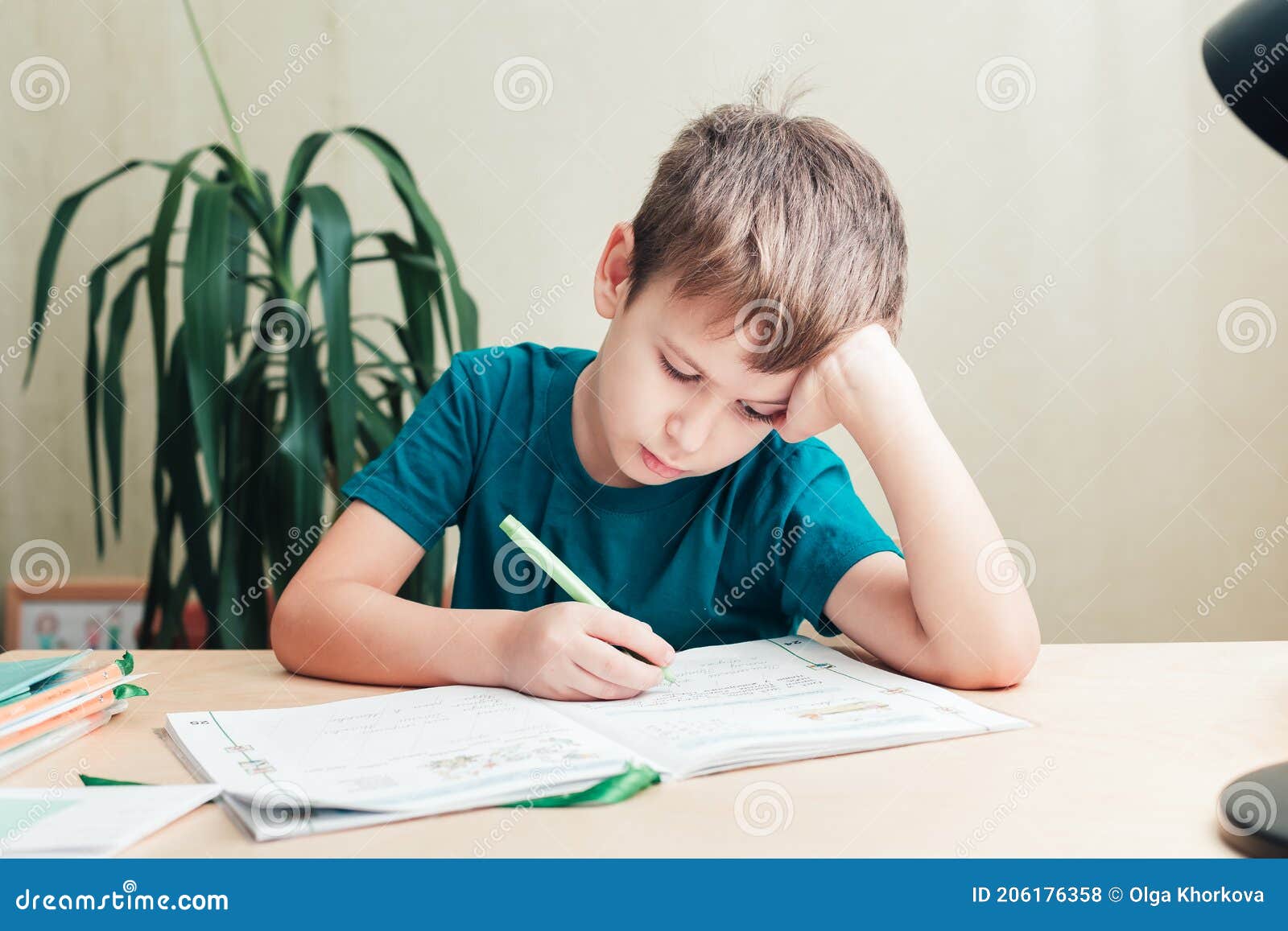 7 Yeas Old Boy Sitting at Desk and Doing Homework Stock Photo - Image ...