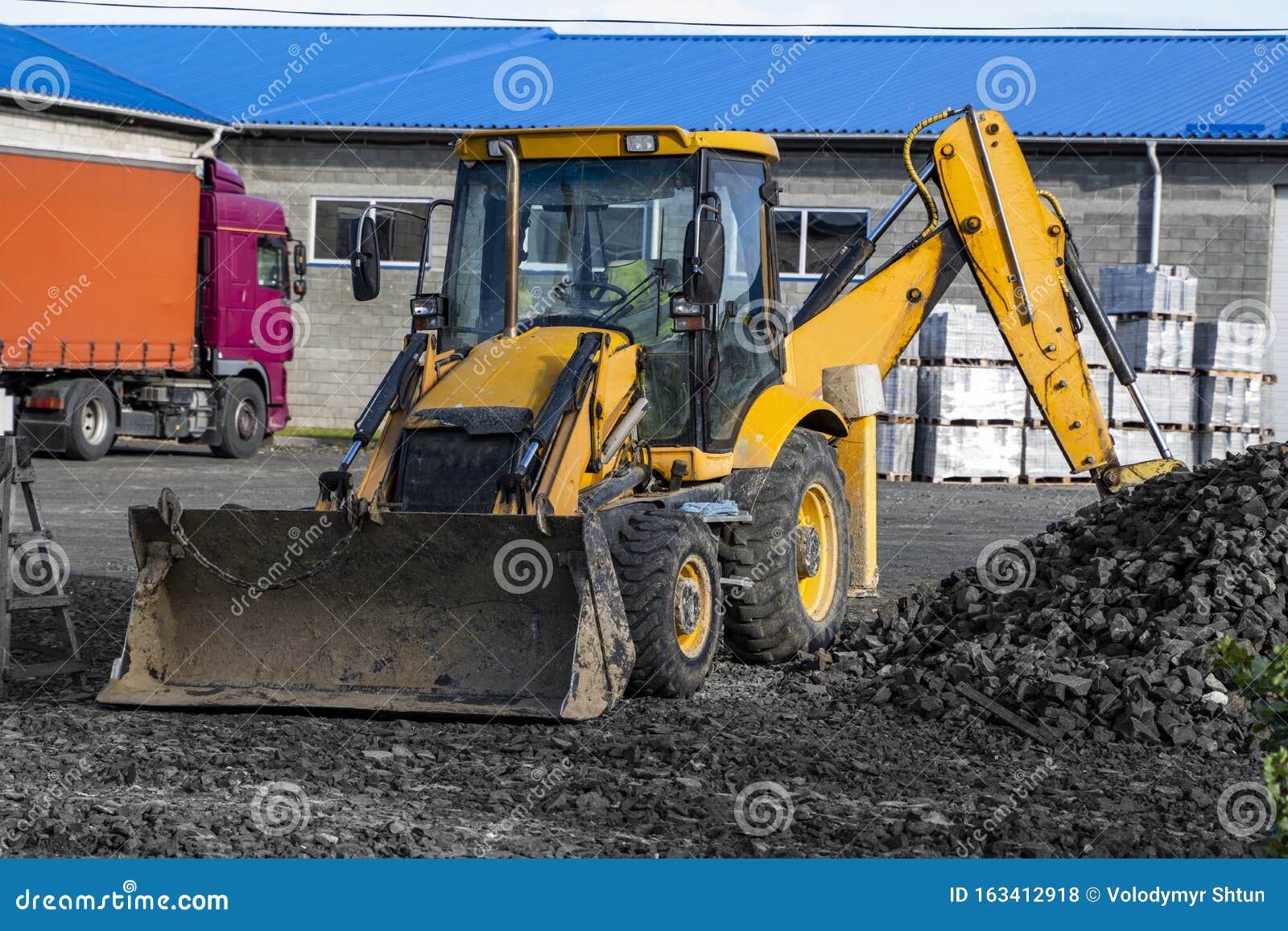 The Yellow All-wheel Drive Backhoe Loader Stands on the Yard Ready for ...