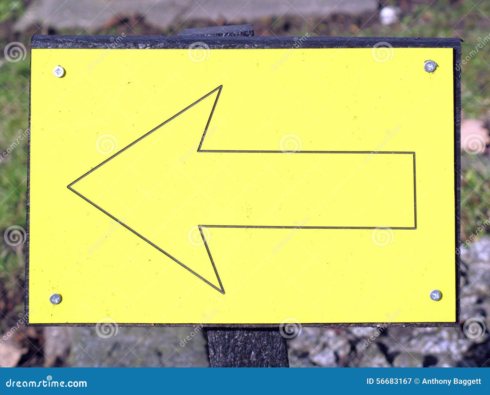 Yellow Arrow Sign Pointing this Way Left Stock Image - Image of screws ...