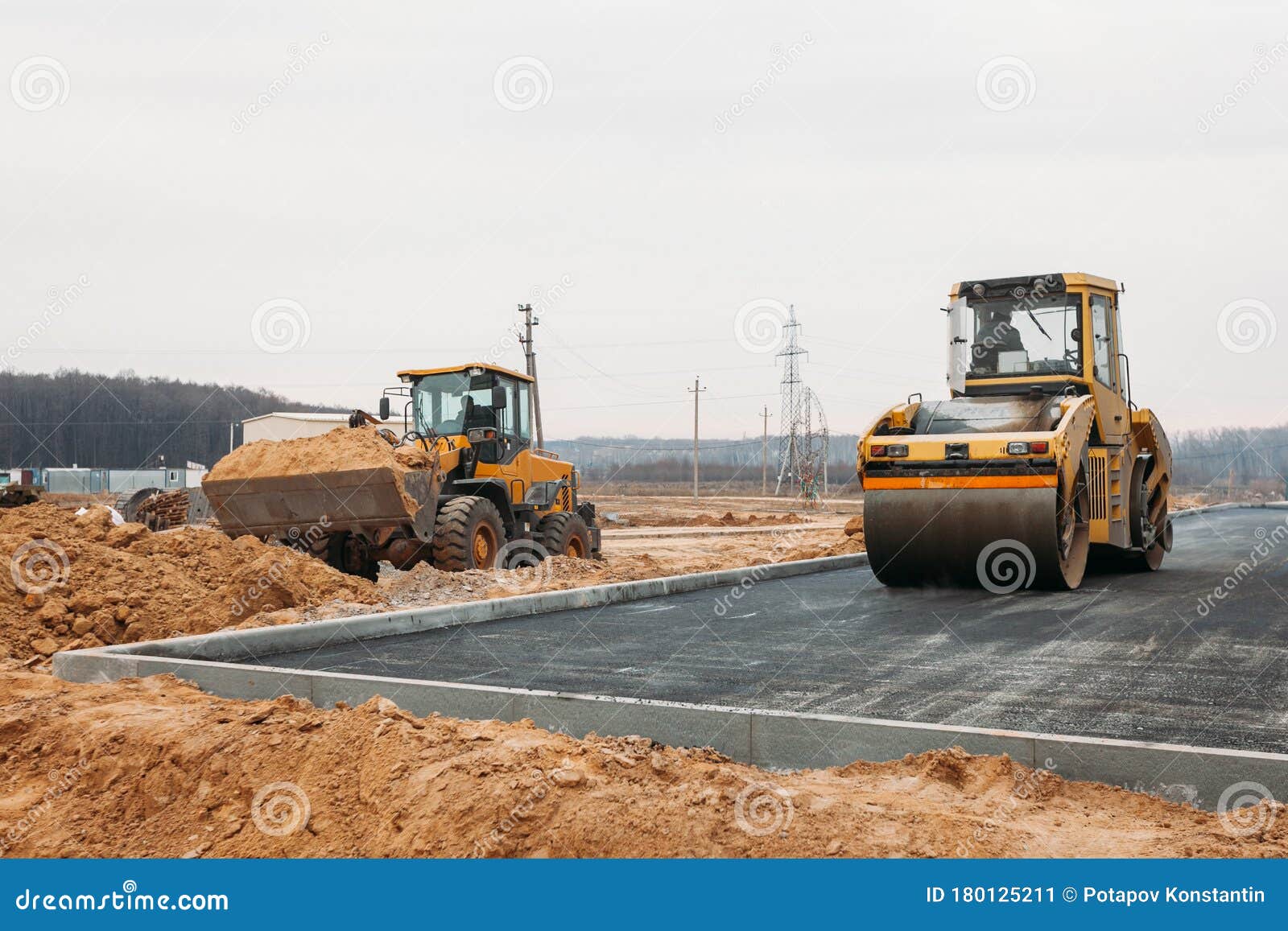 Yellow Asphalt Compactor at Work and Orange Bulldozer with Sand in the ...