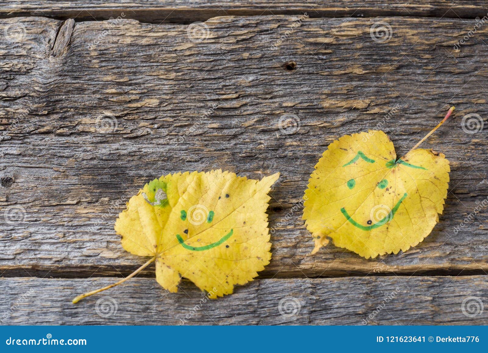 Yellow Autumn Leaves with Smiley Patterns on Wooden Background. Stock ...