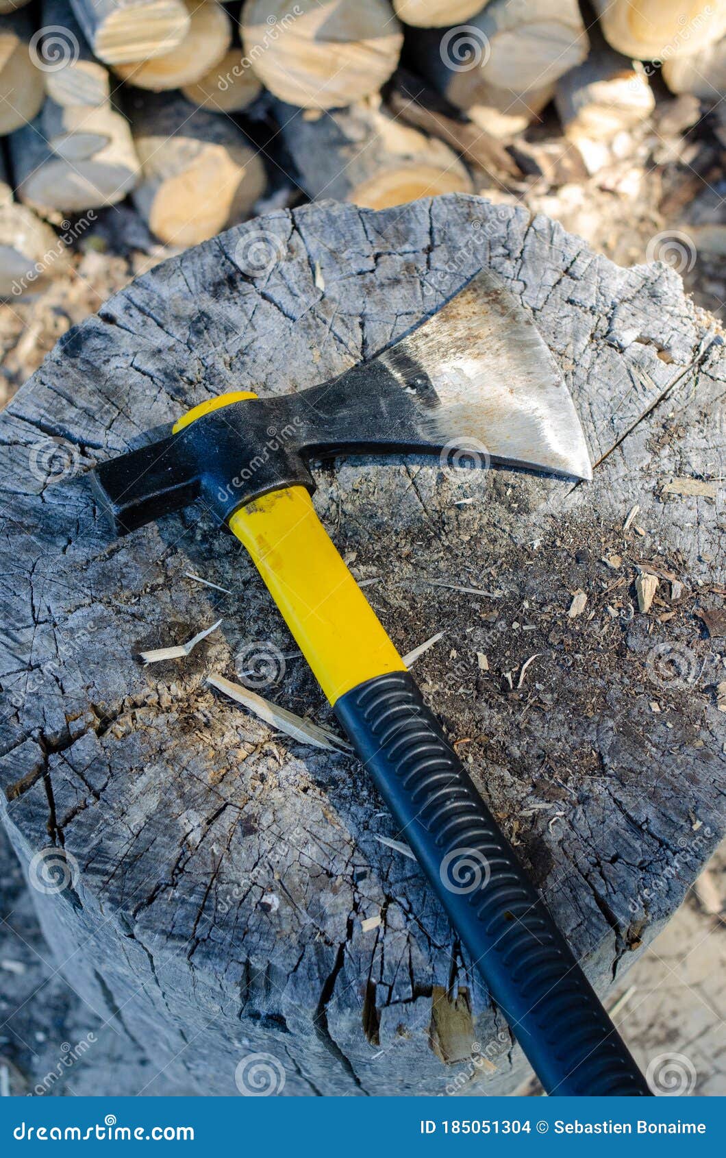 Axe With A Piece Of Wood Near A Stack Of Logs Stock Photo ...